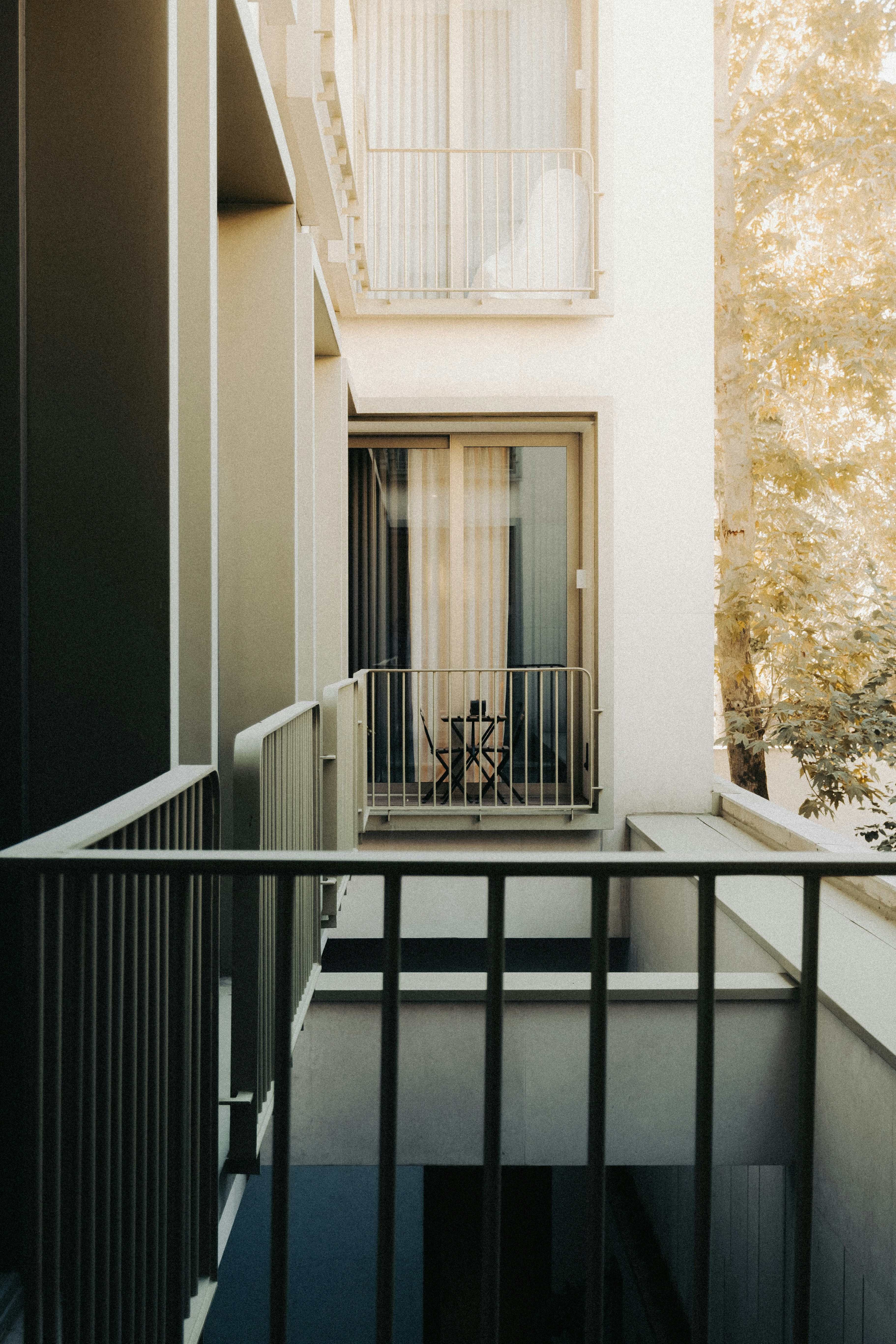 Vertical Courtyard Quiet: An Street-View of Balconies and Railings