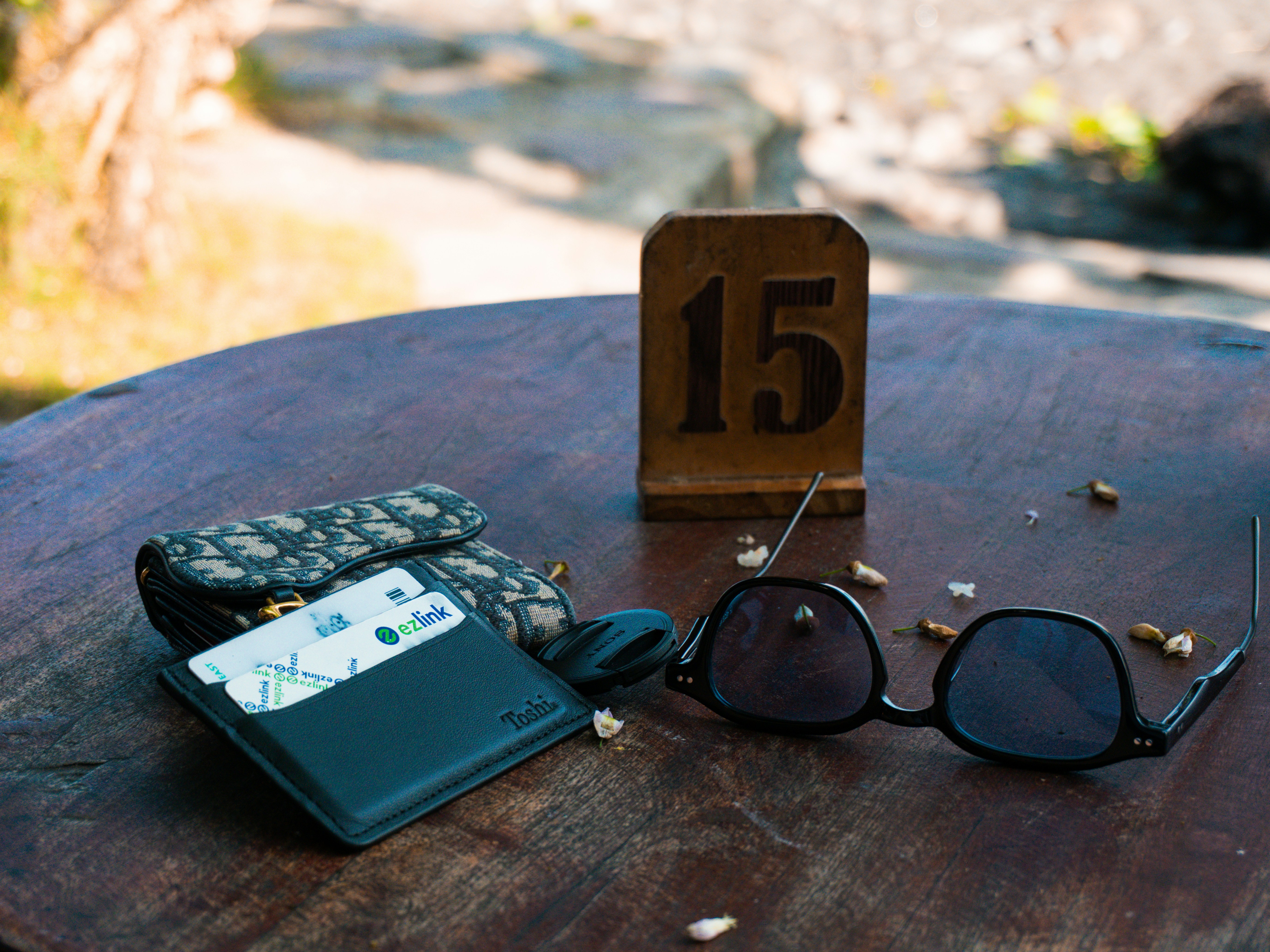 Sundial and Sunglasses on a Weathered Table