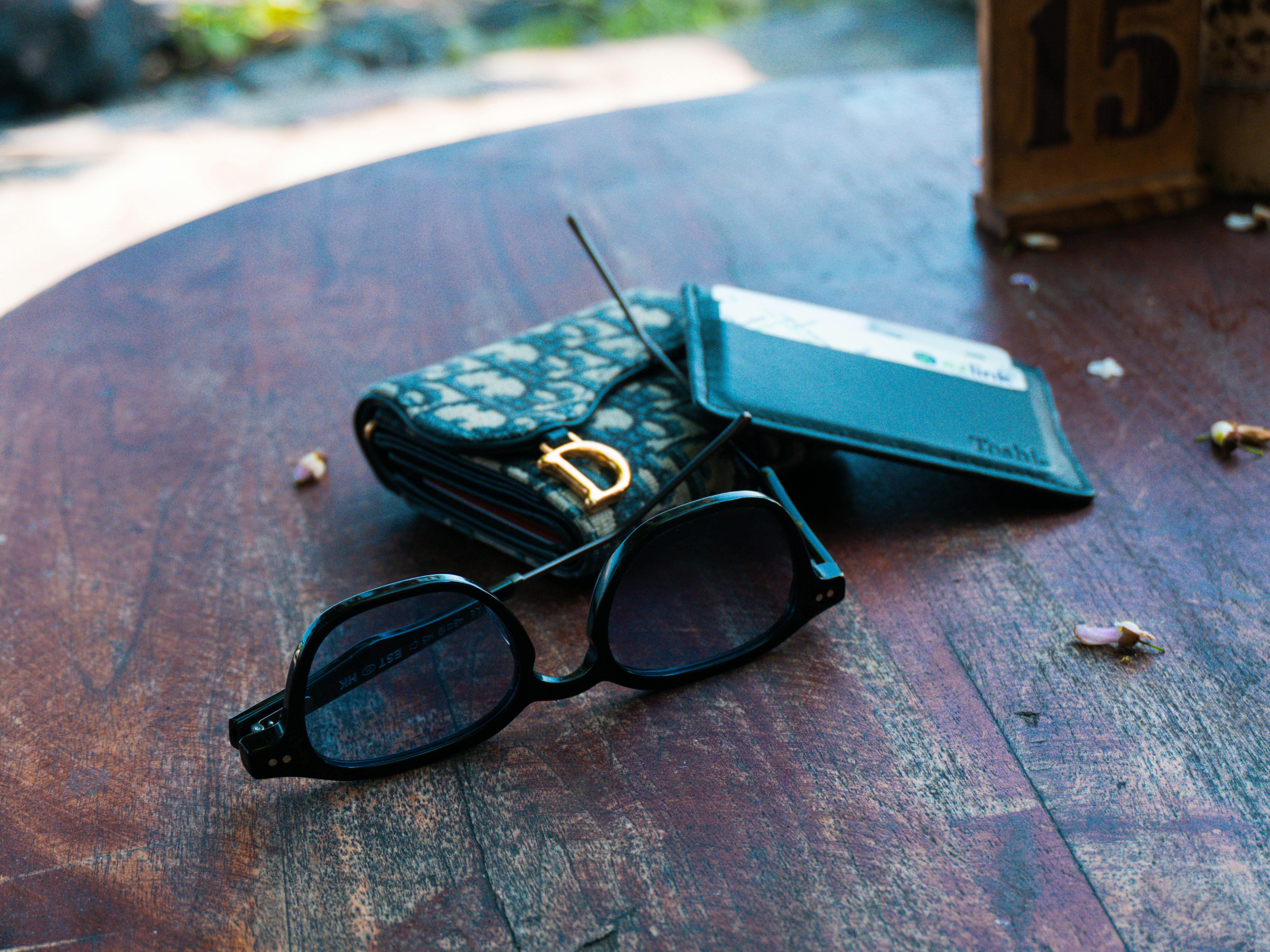 Glasses and Wallet Resting on Weathered Table
