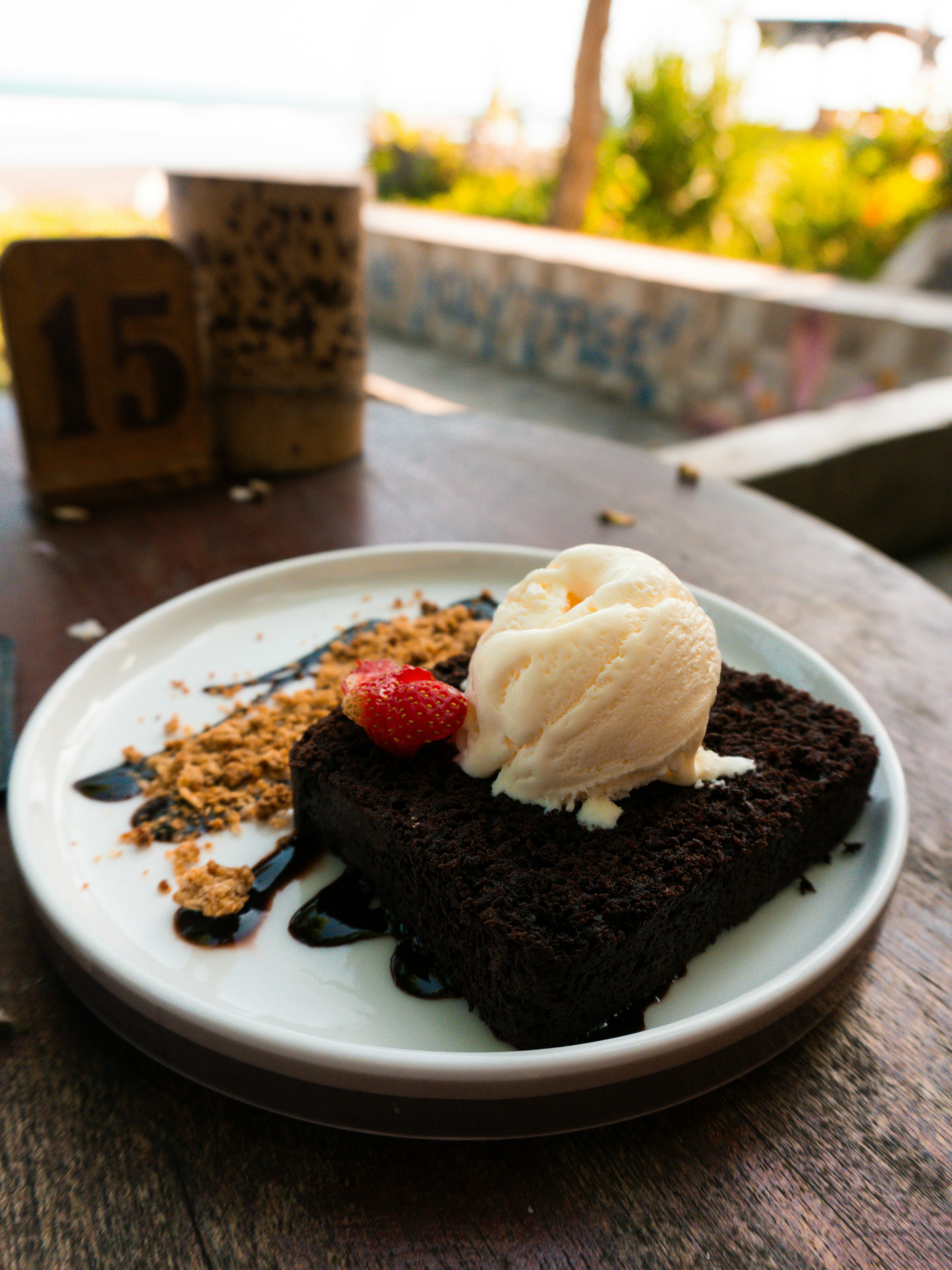 Decadent Chocolate Brownie With Vanilla Ice Cream on a Rustic Table