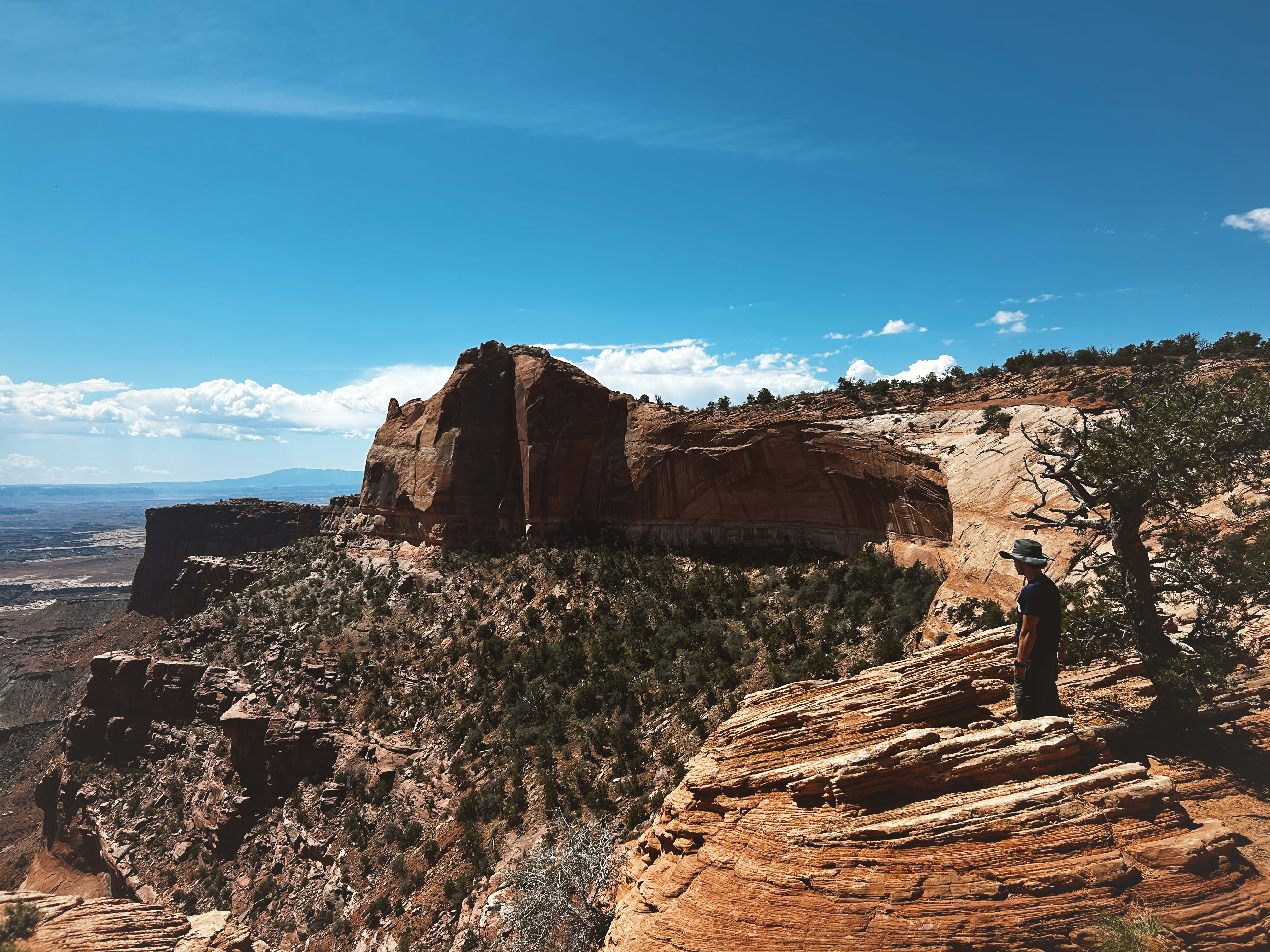 Cliffside Gaze: A Lone Figure Over the Desert Edge