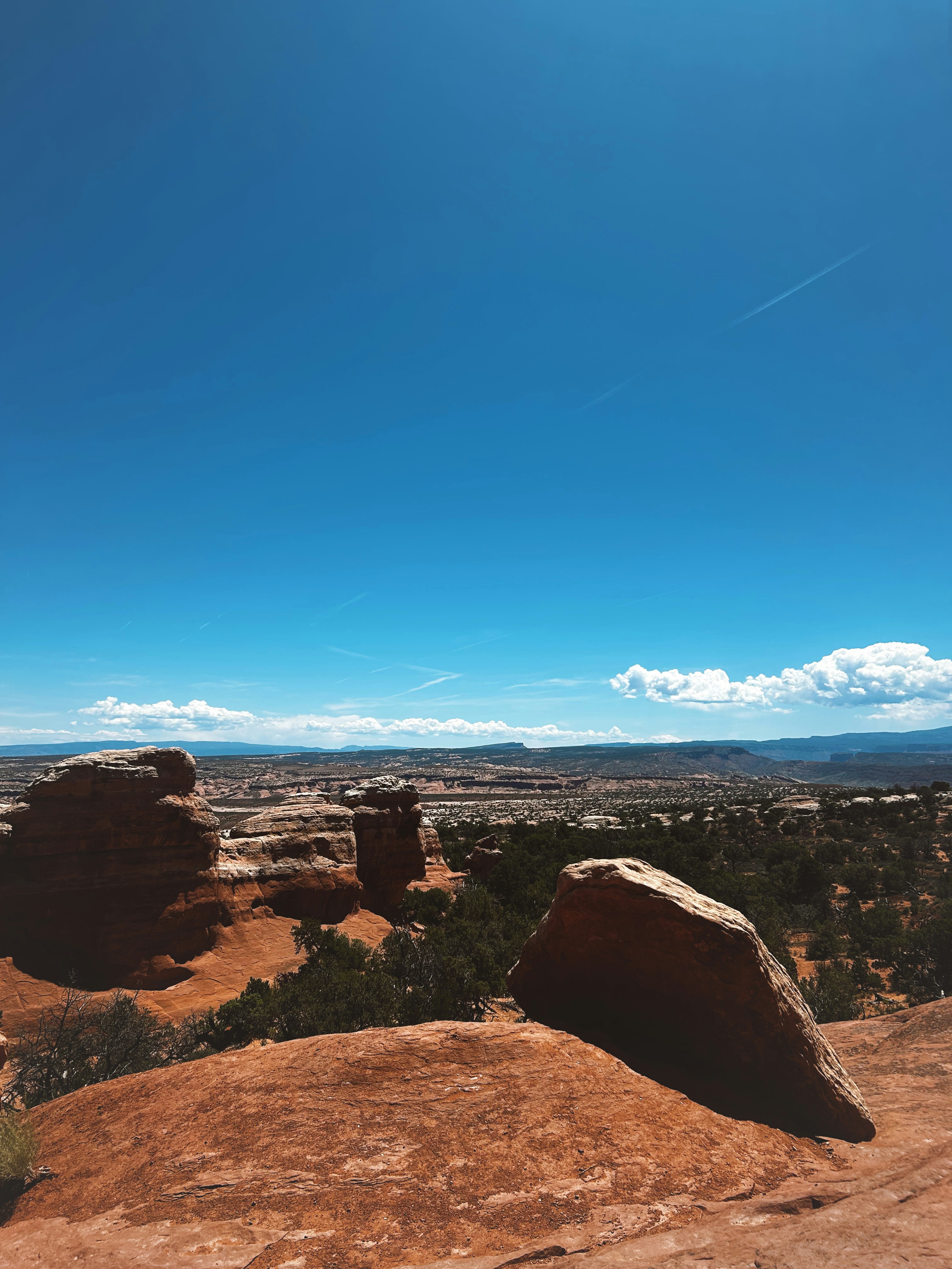 Red rock desert landscape under a bright blue sky.