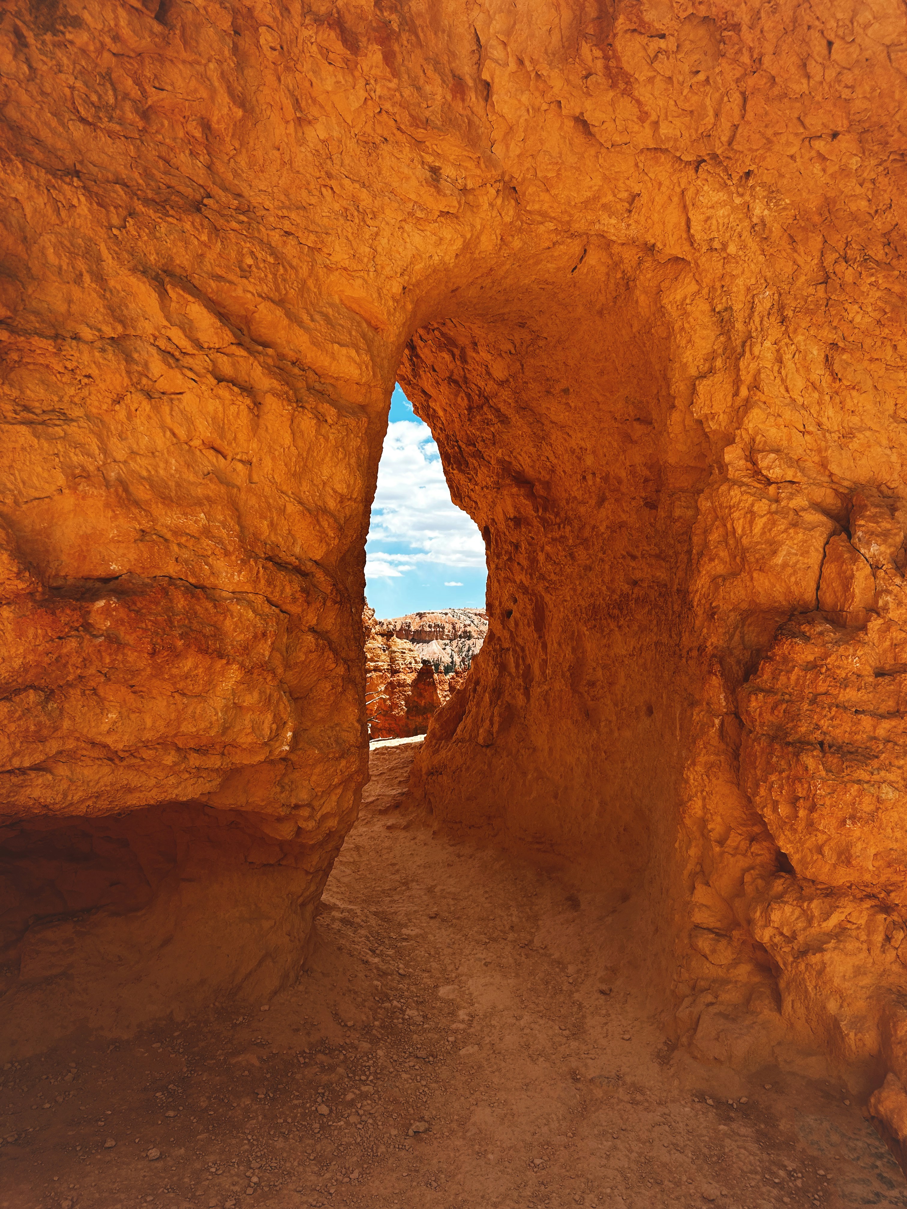 Through the Oxide Arch: Sunlit Passage Between Rusty Walls