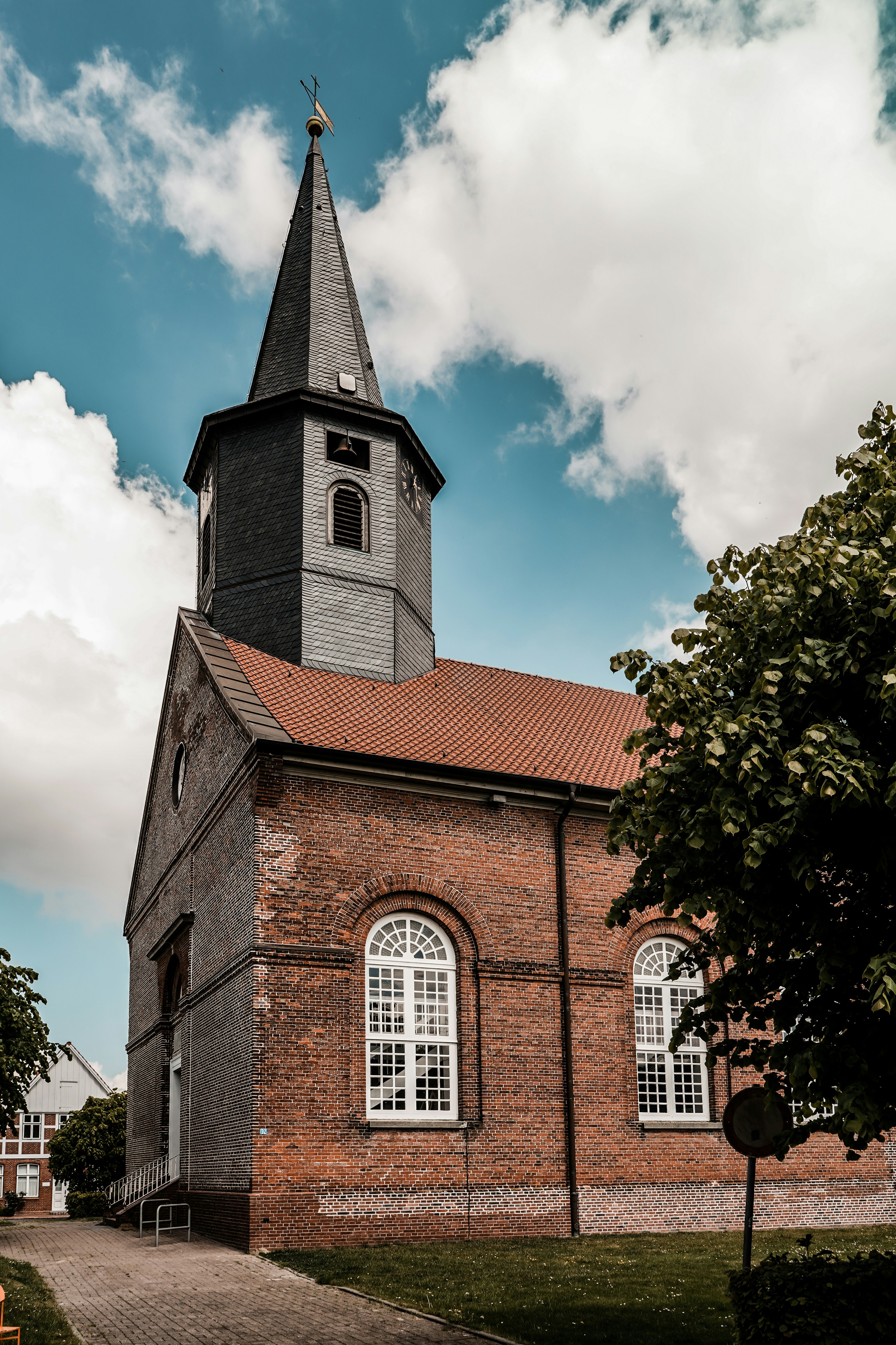 Brick Church with Tower Reaching Toward a Bright Sky