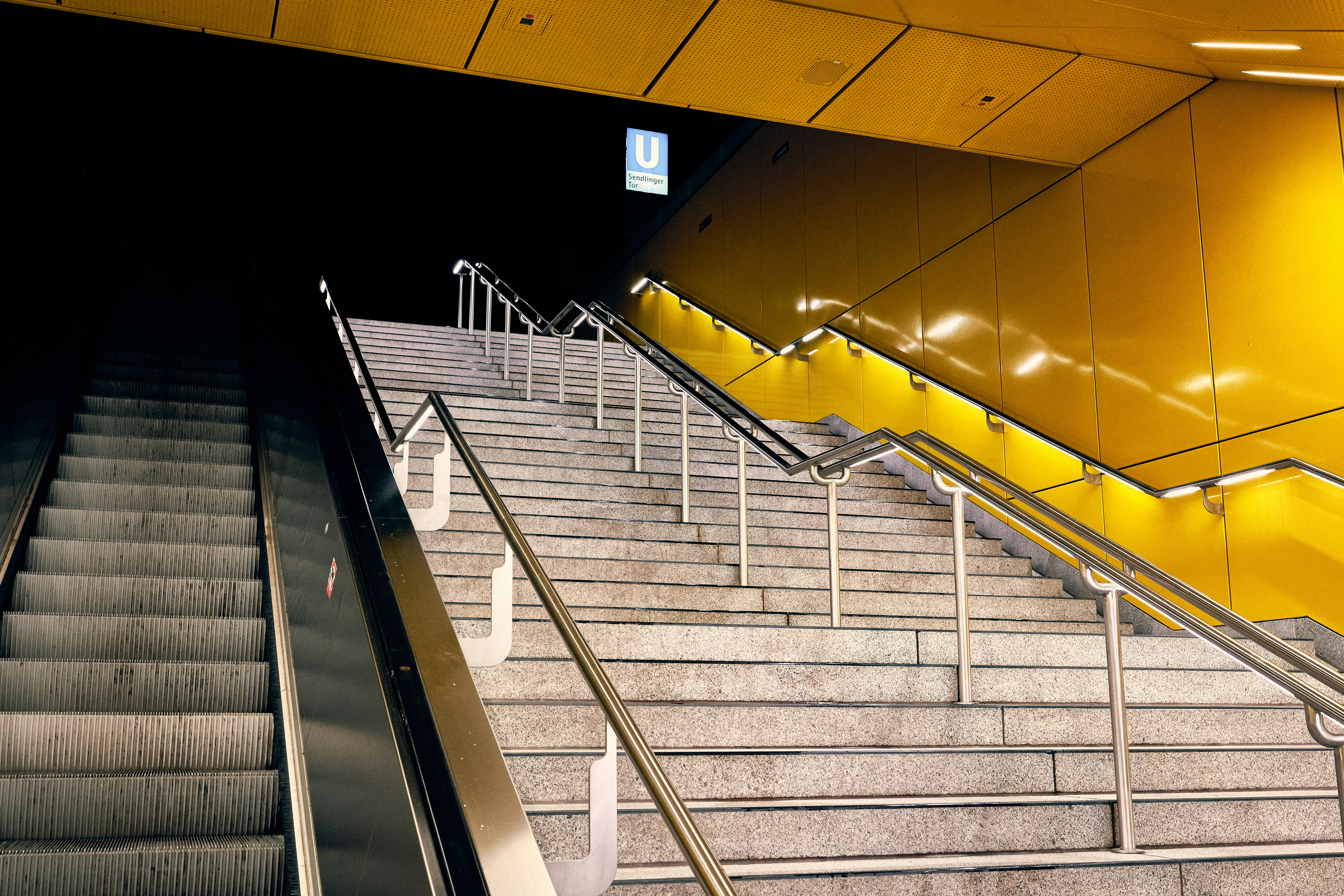 Geometric Ascent: Neon-Touched Stairs of a Suburban Metro