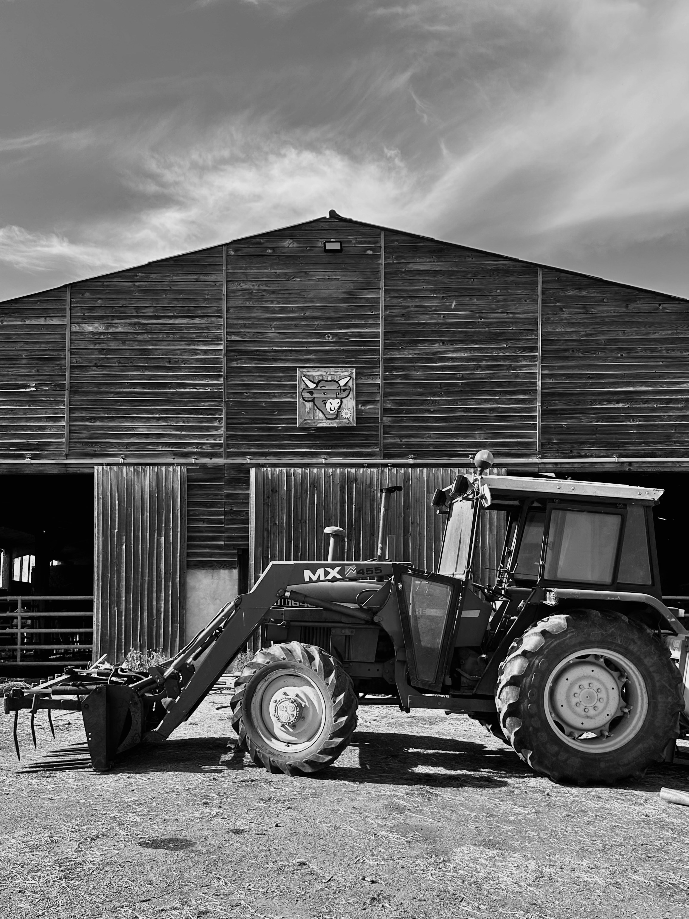 Barn Doorway and Tractor: Quiet Farmyard in Monochrome