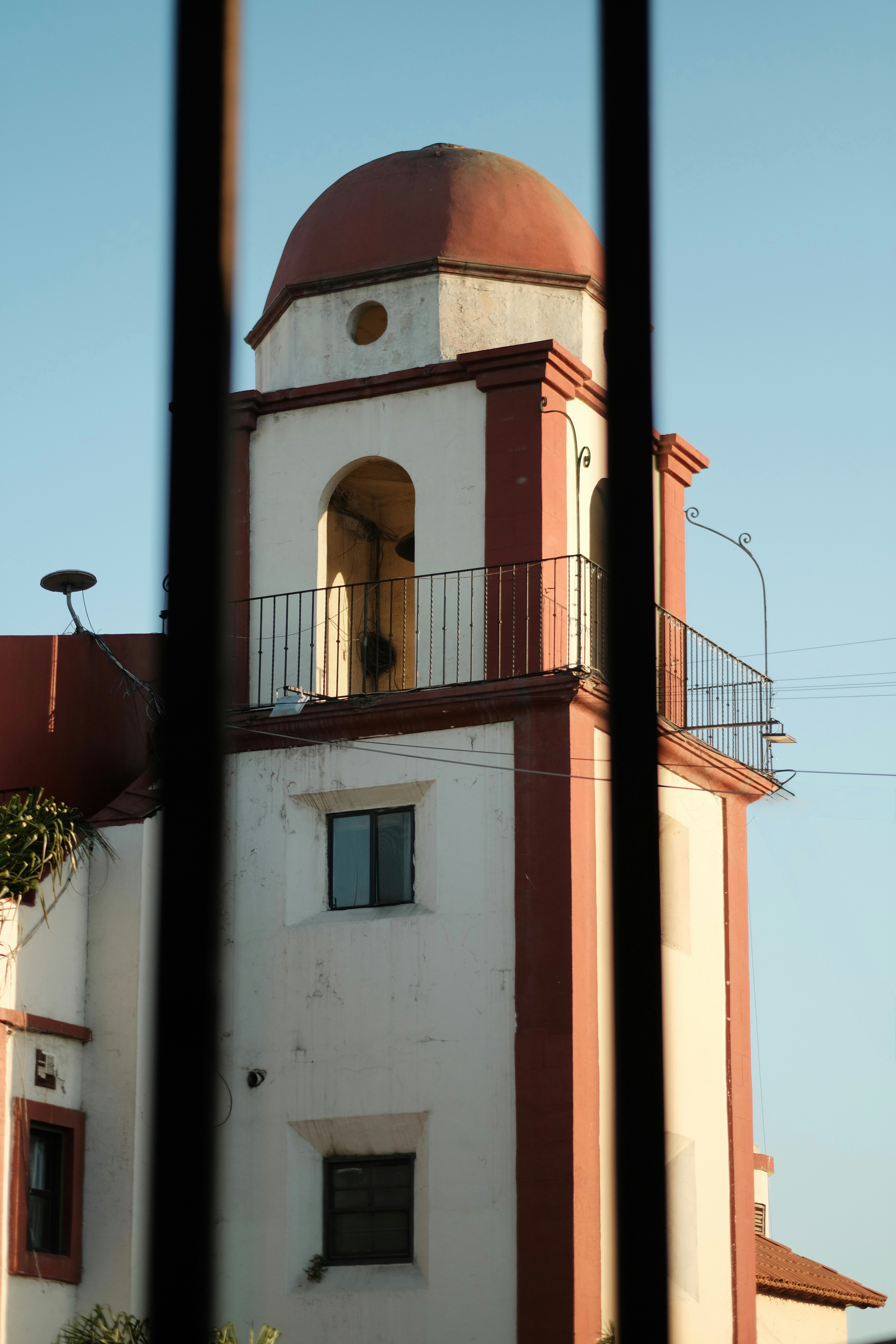 Towered Tone: A Balcony and Dome Framed by Bars