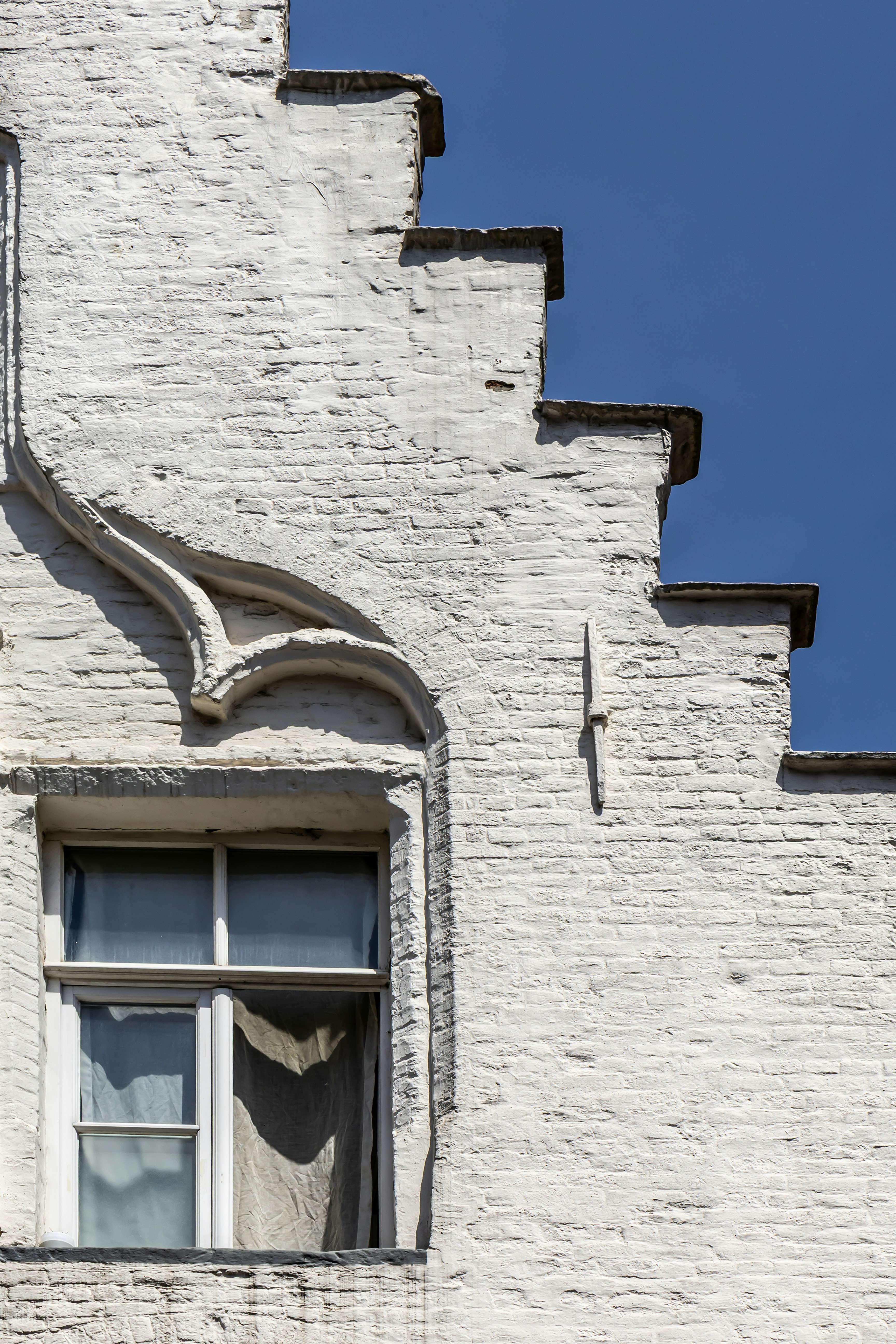 Stepped White Facade Under a Blue Sky