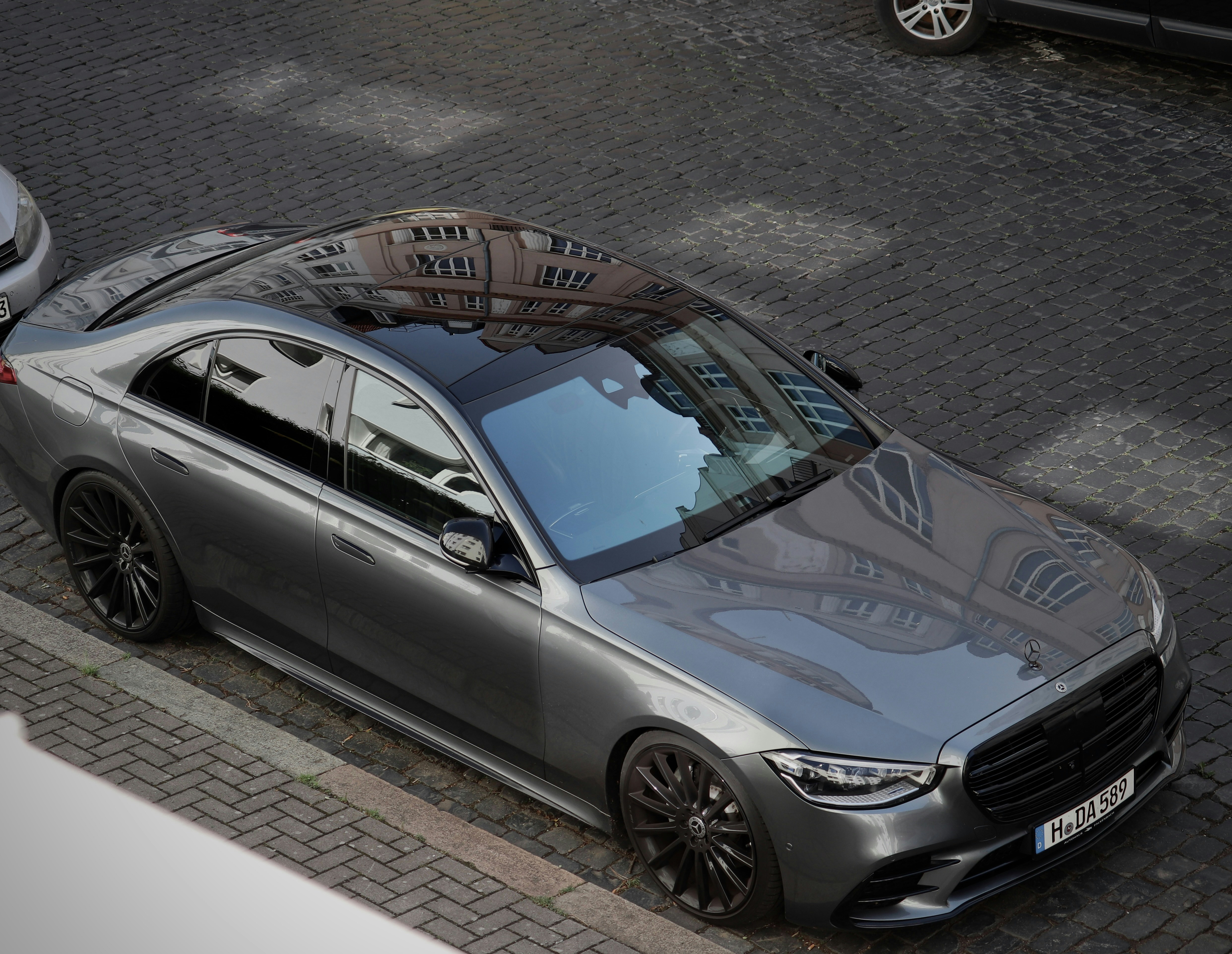 Sleek Mercedes Seduction: A Silver Stalwart Resting on Cobblestones