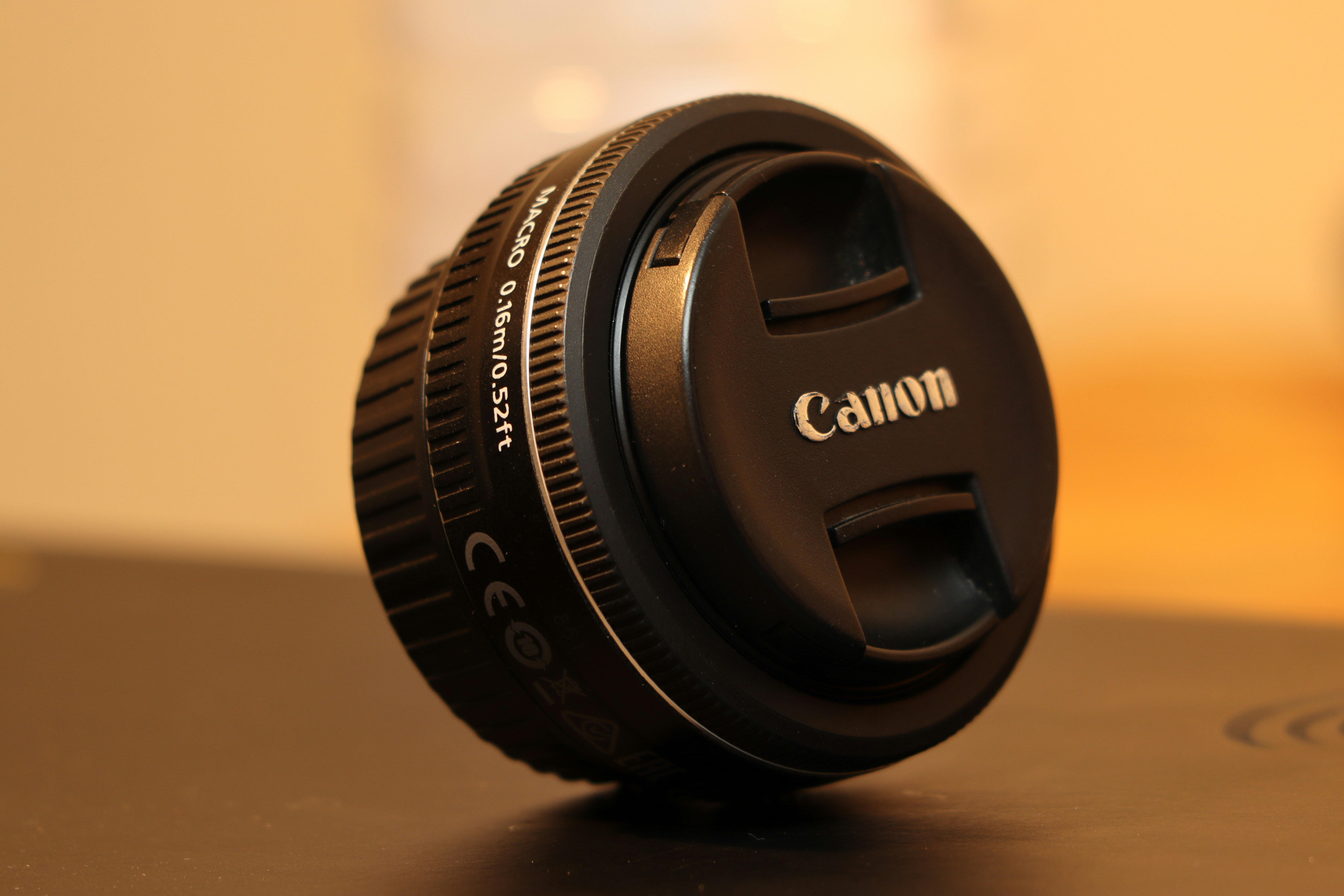 Canon in Focus: A Close-Up of a Canon Lens Cap Resting on a Quiet Surface