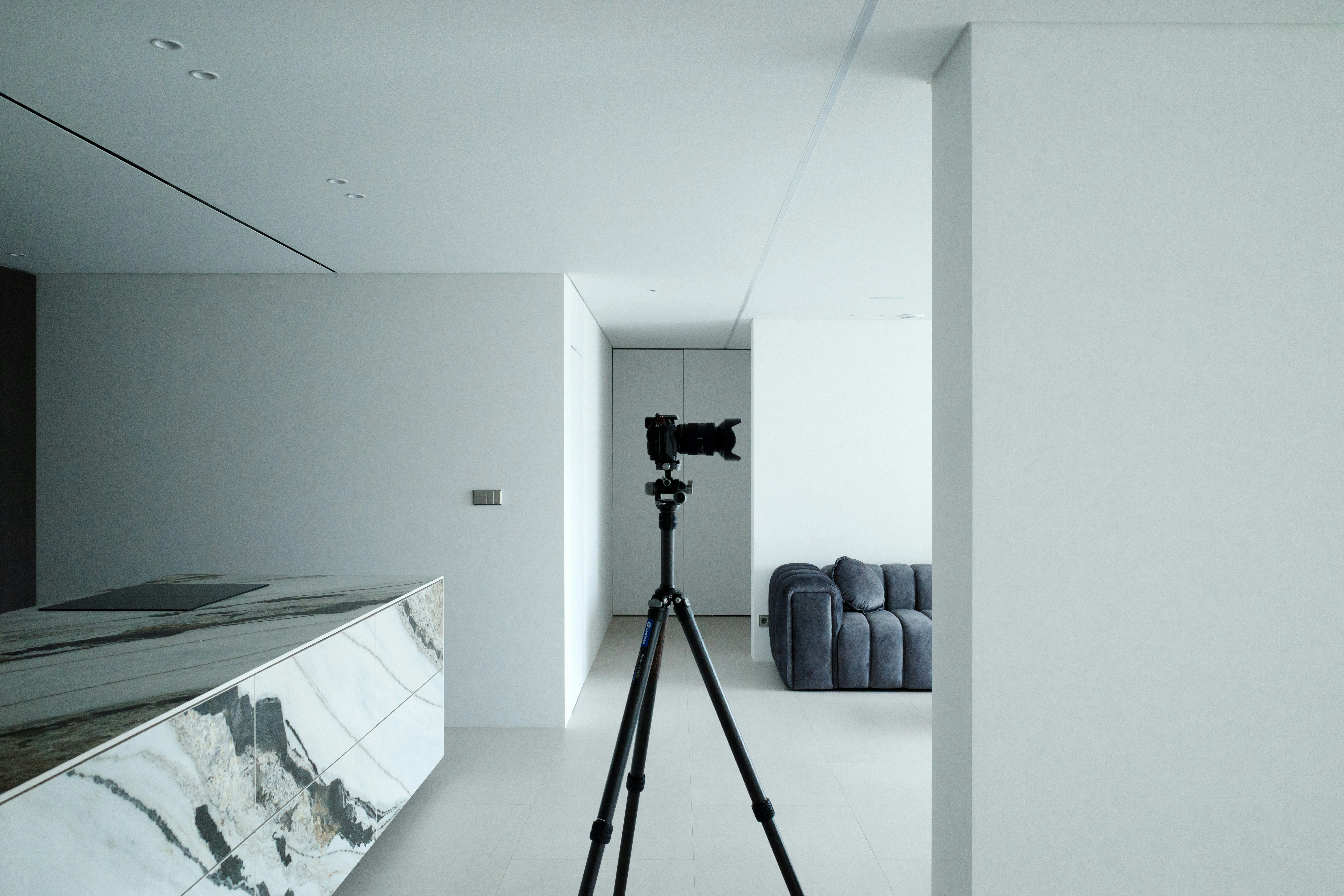 Empty Hall, Focused View: A Tripod Stands In a Minimalist Studio