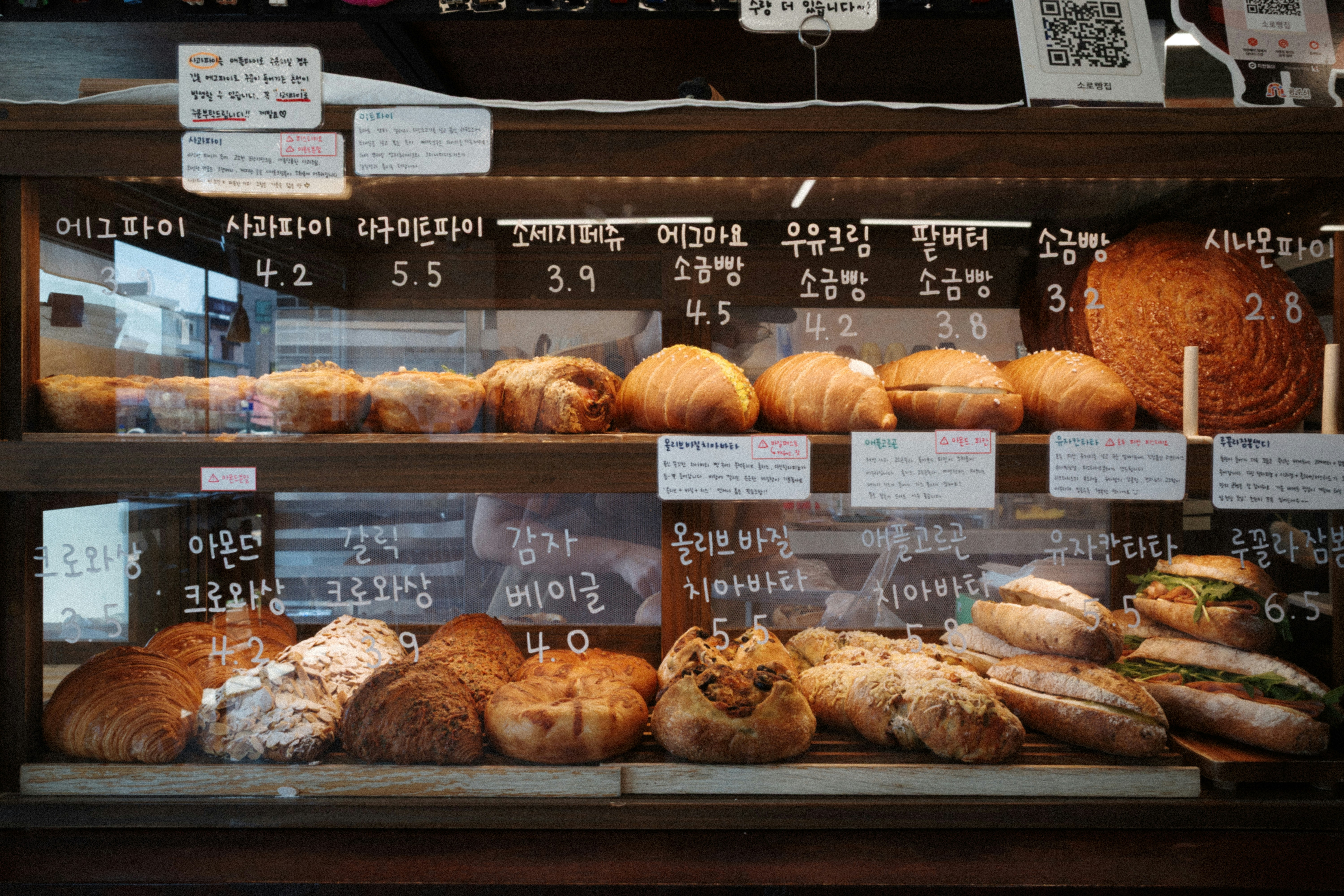 Rows of Golden Croissants and Breads in a Quiet Bakery Display