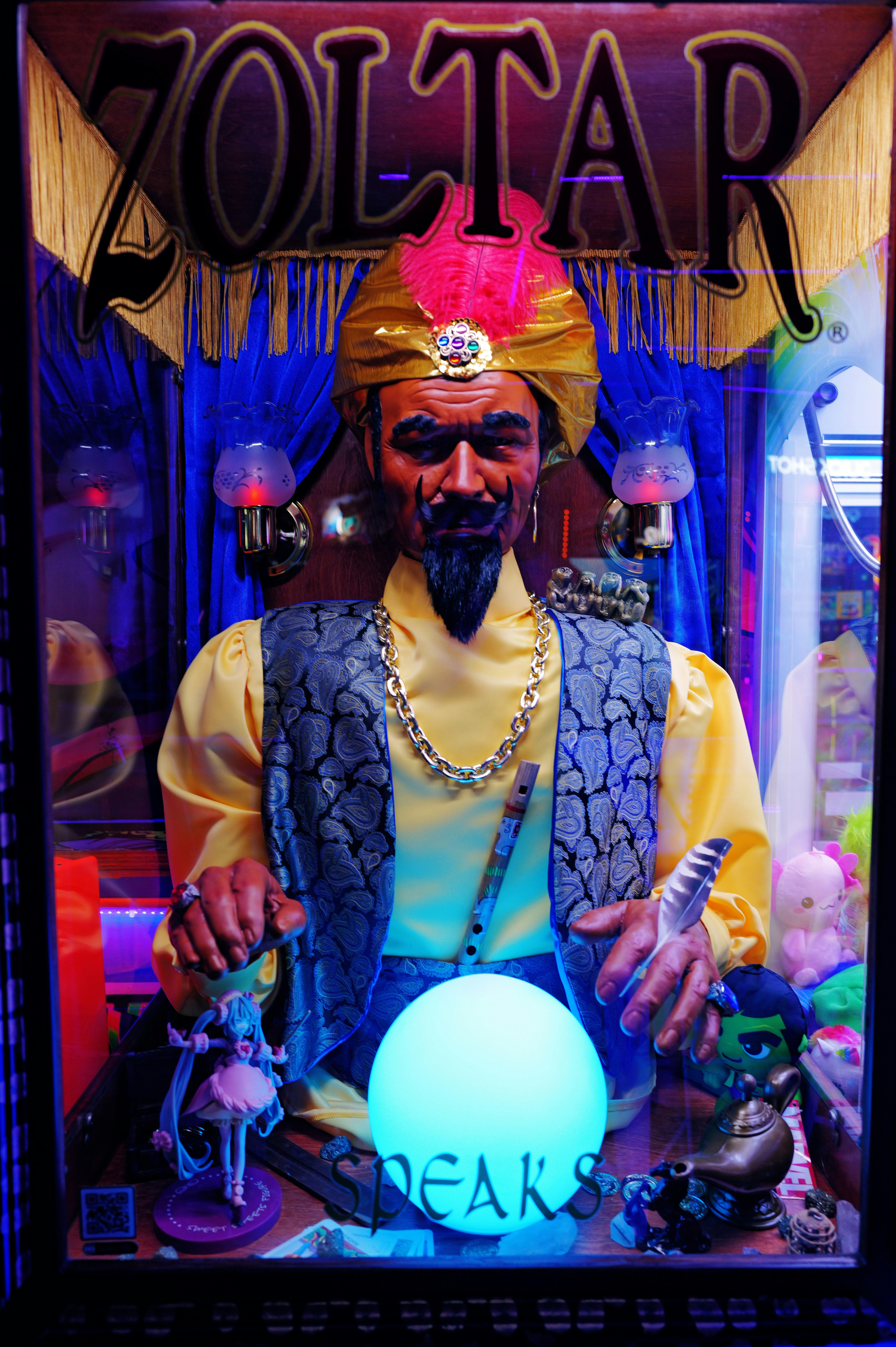 An animatronic zoltar fortune teller with a glowing crystal ball.