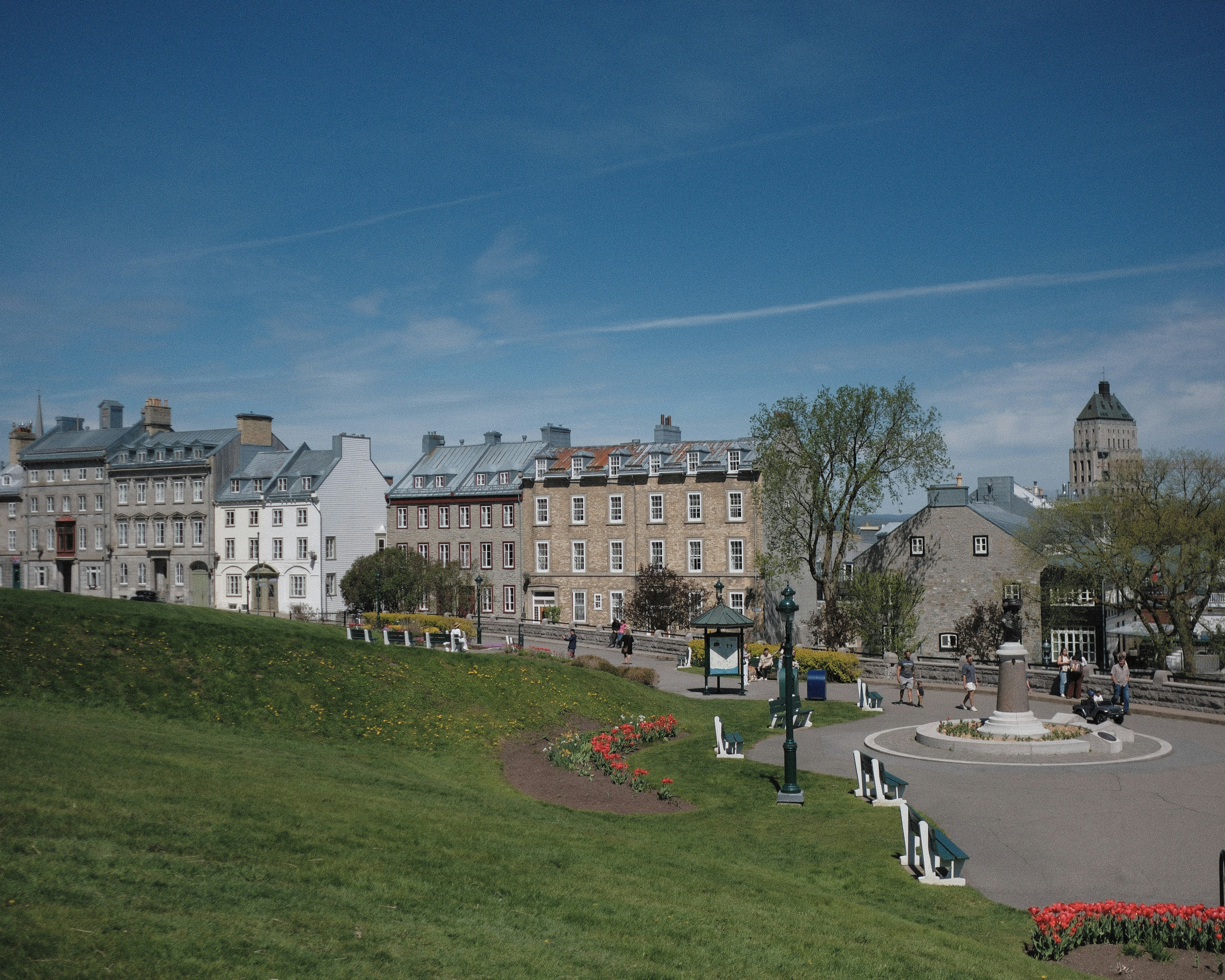 Sunlit Prospect: A Quiet Town Square with Floral Crescent