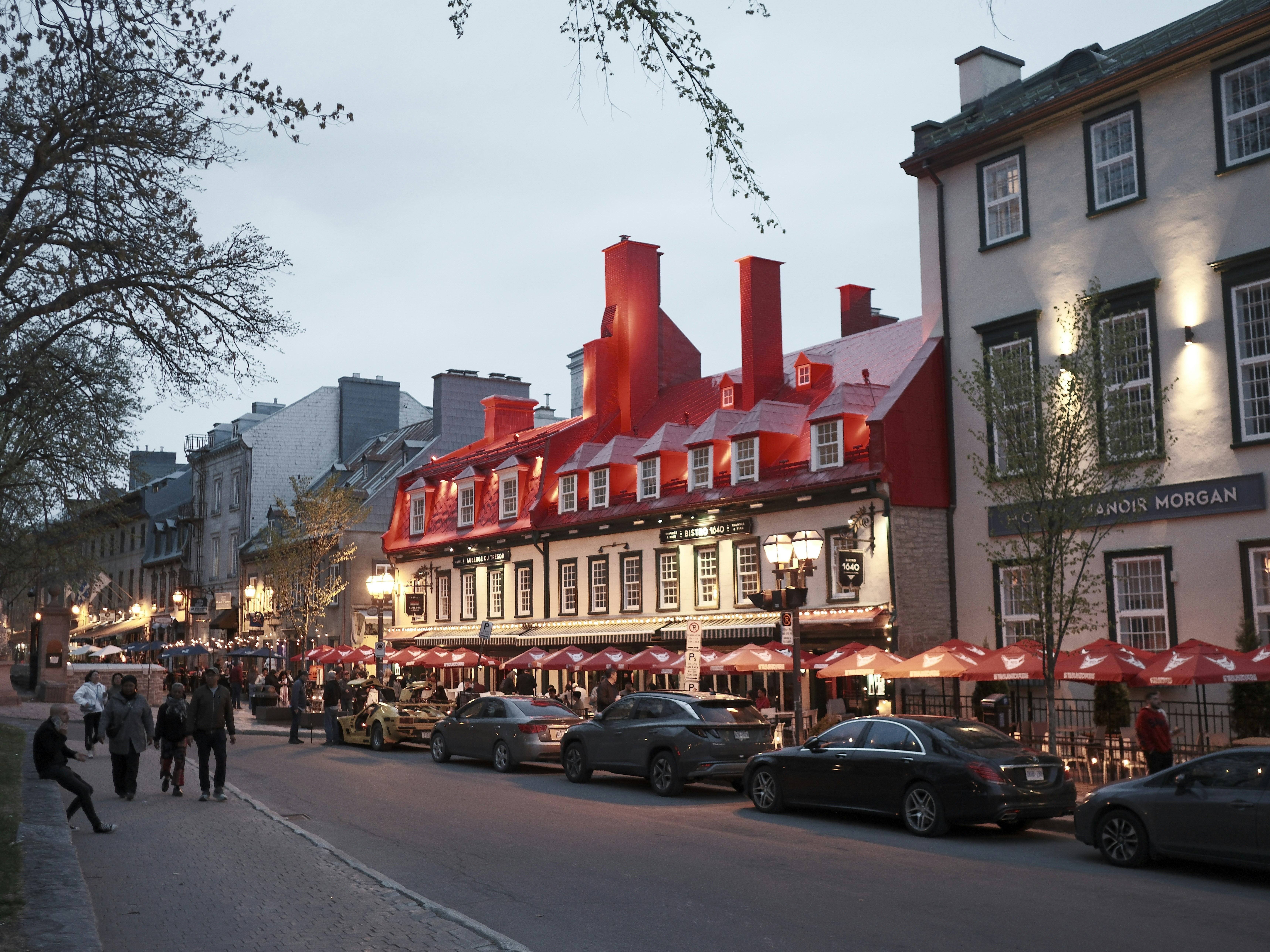 Bright Red Rooftops and Nightlife on a Historic Tranquil Street