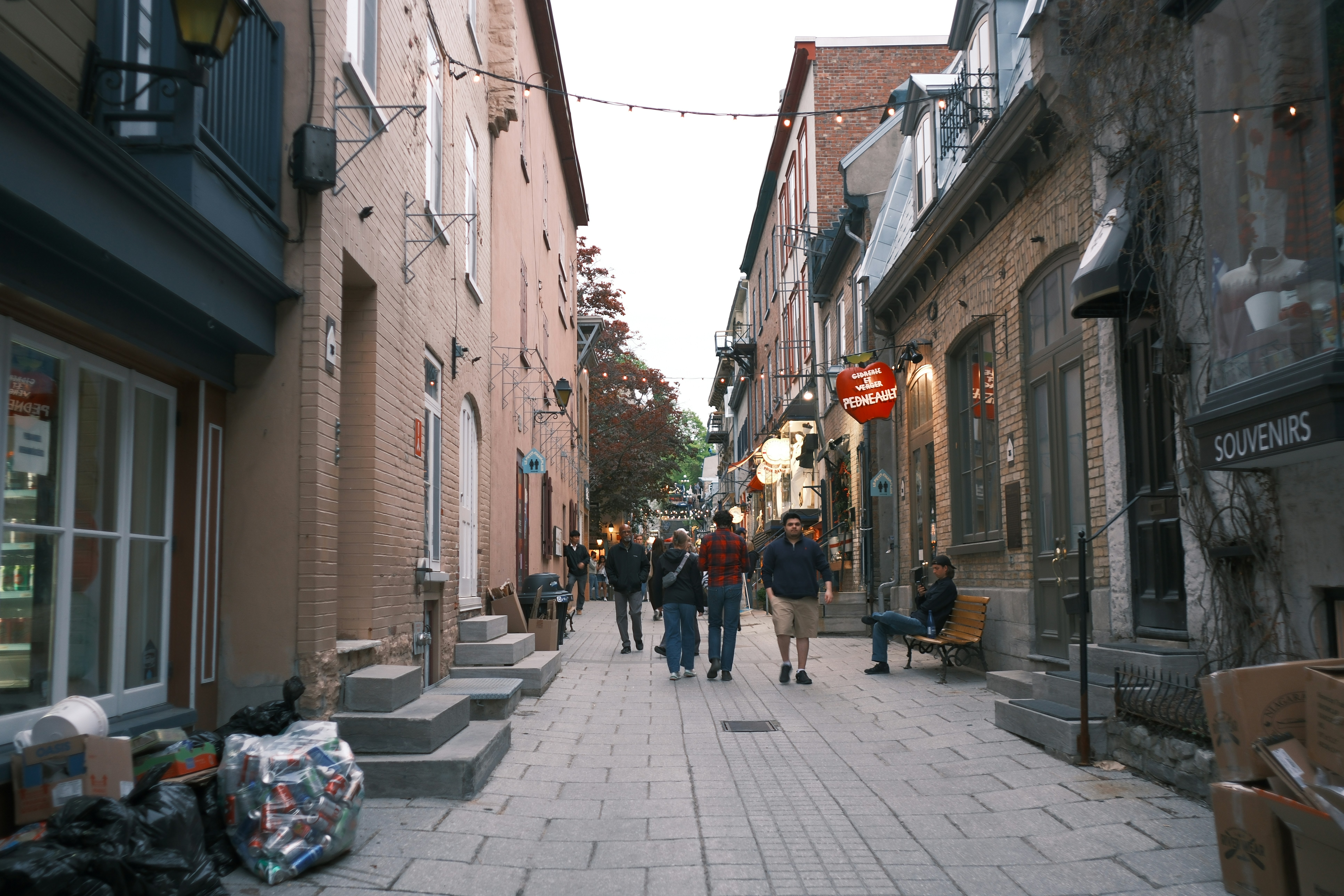Quiet Street, Busy Moments: A Midday Corridor of Brick and Light