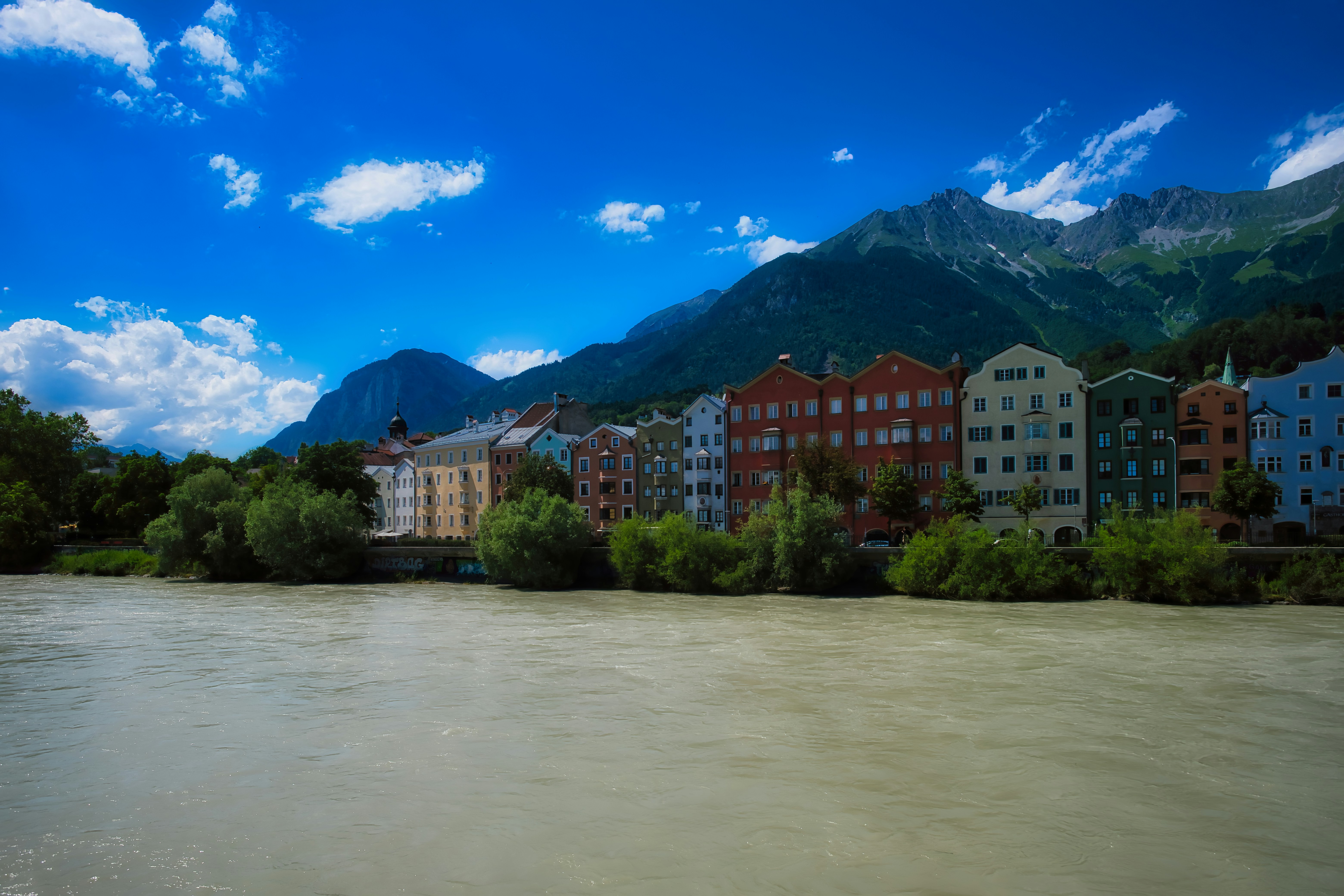 Colorful riverside village at the foot of sunlit Alps