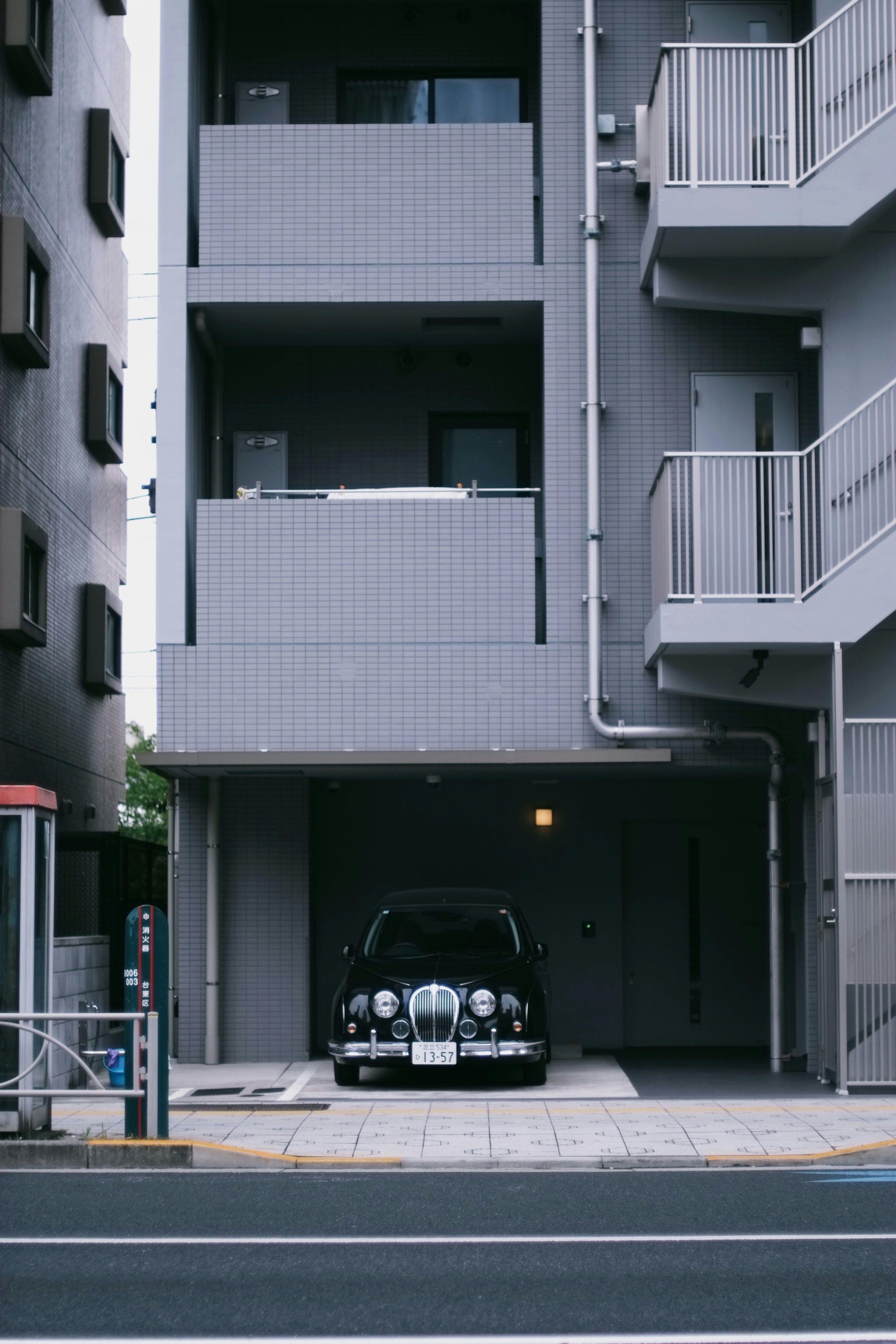 Classic Car in a Quiet Courtyard: Neon-tinged Vertical Urban Scene