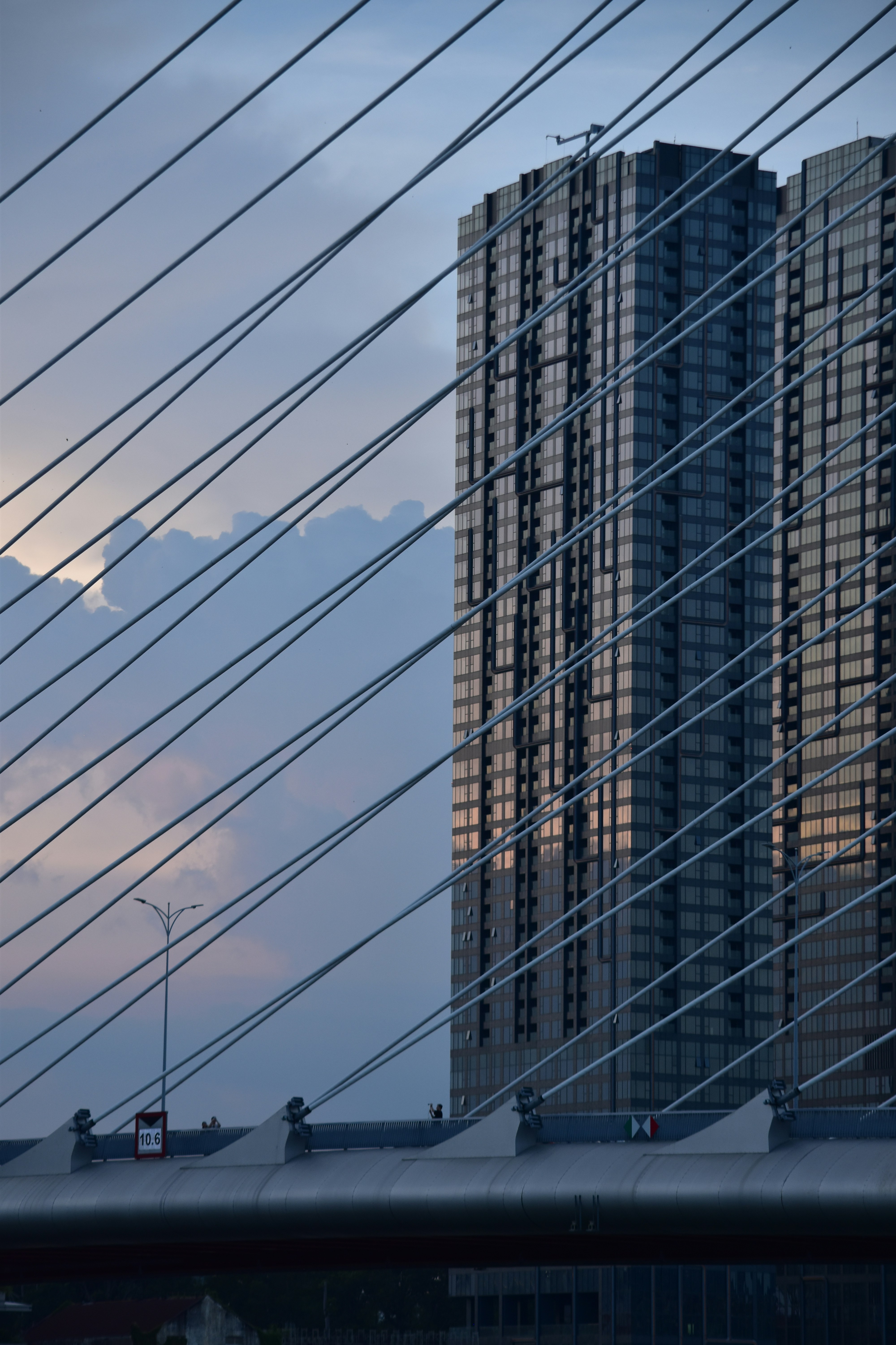 Crisscrossed Sky: A Tower Emerges Behind Utility Cables