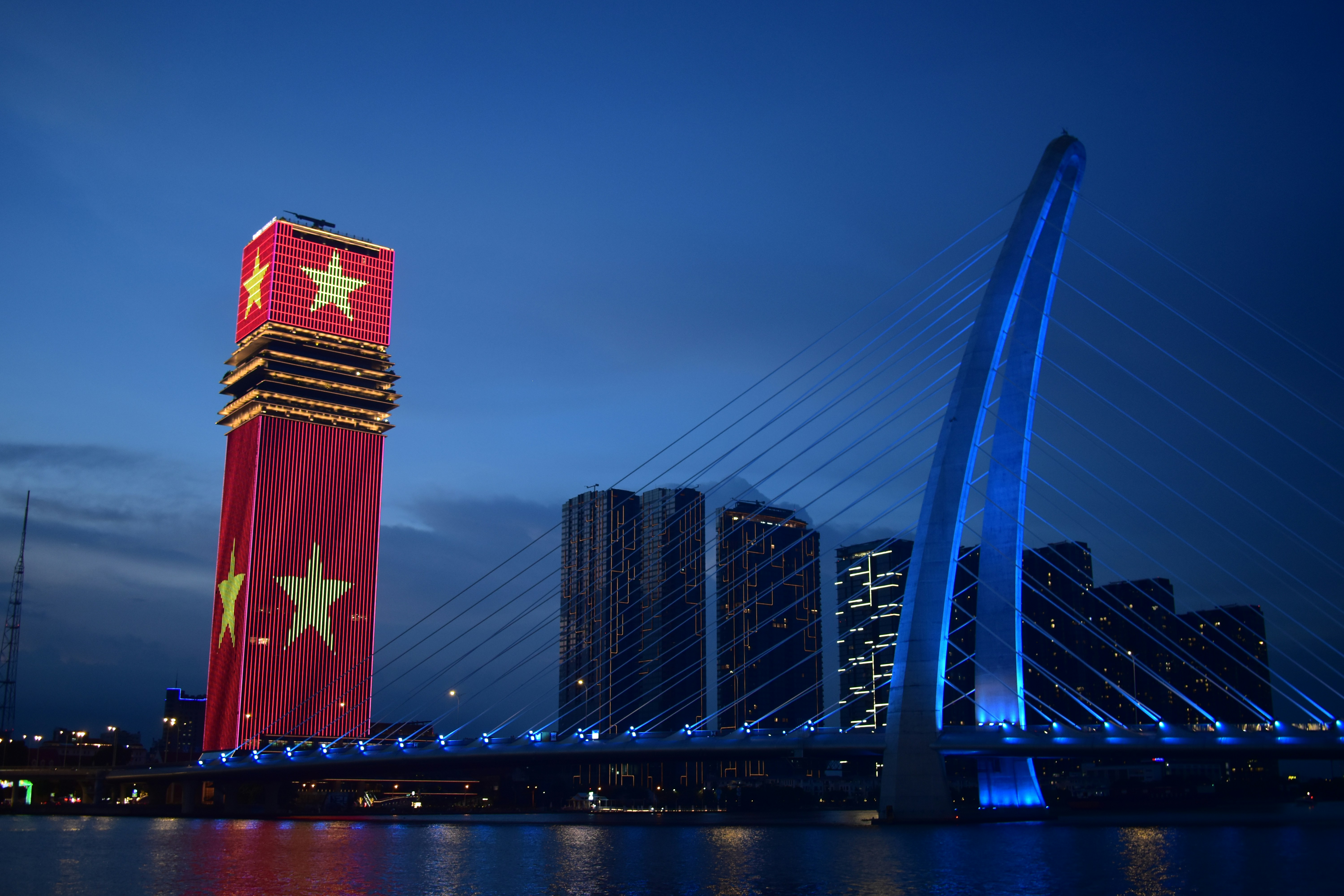 Towering Red Banner Adrift: A Night Vista of the Moonlit Skyline