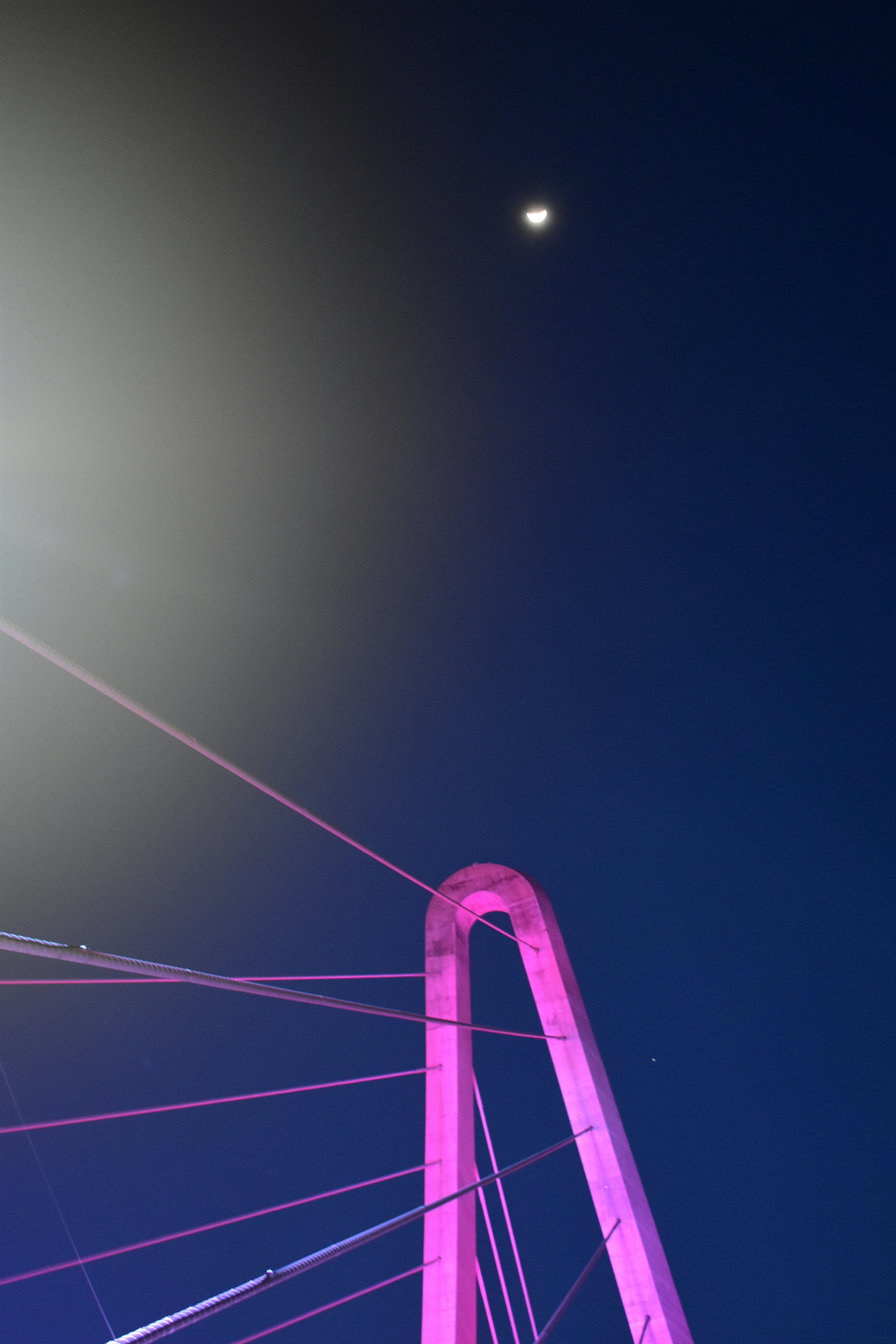 Neon Arch: Night Bridge with Pink Cables under a Crescent Moon