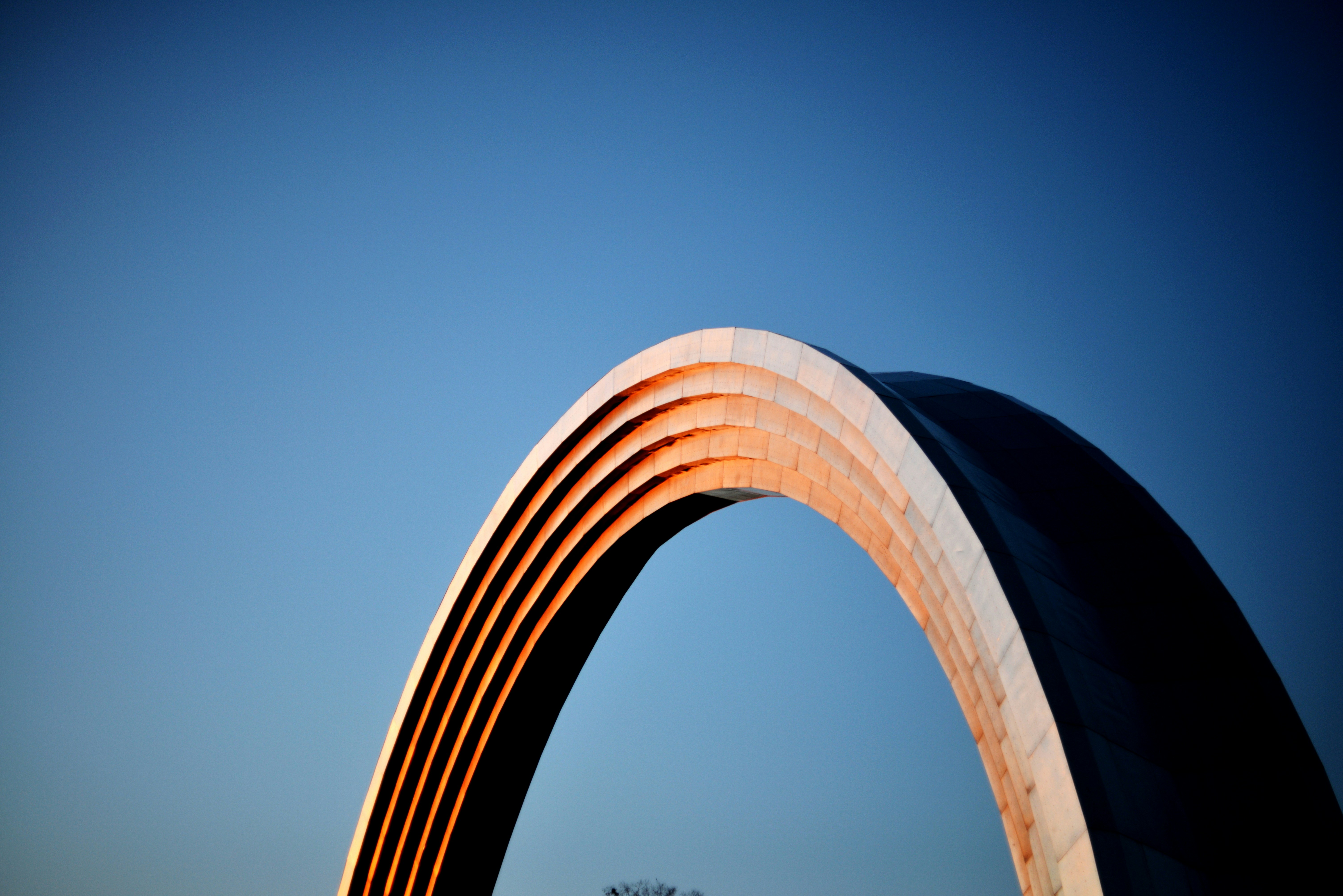 Sunlit Arch: A Crescent of Steel Rising Against a Clear Sky