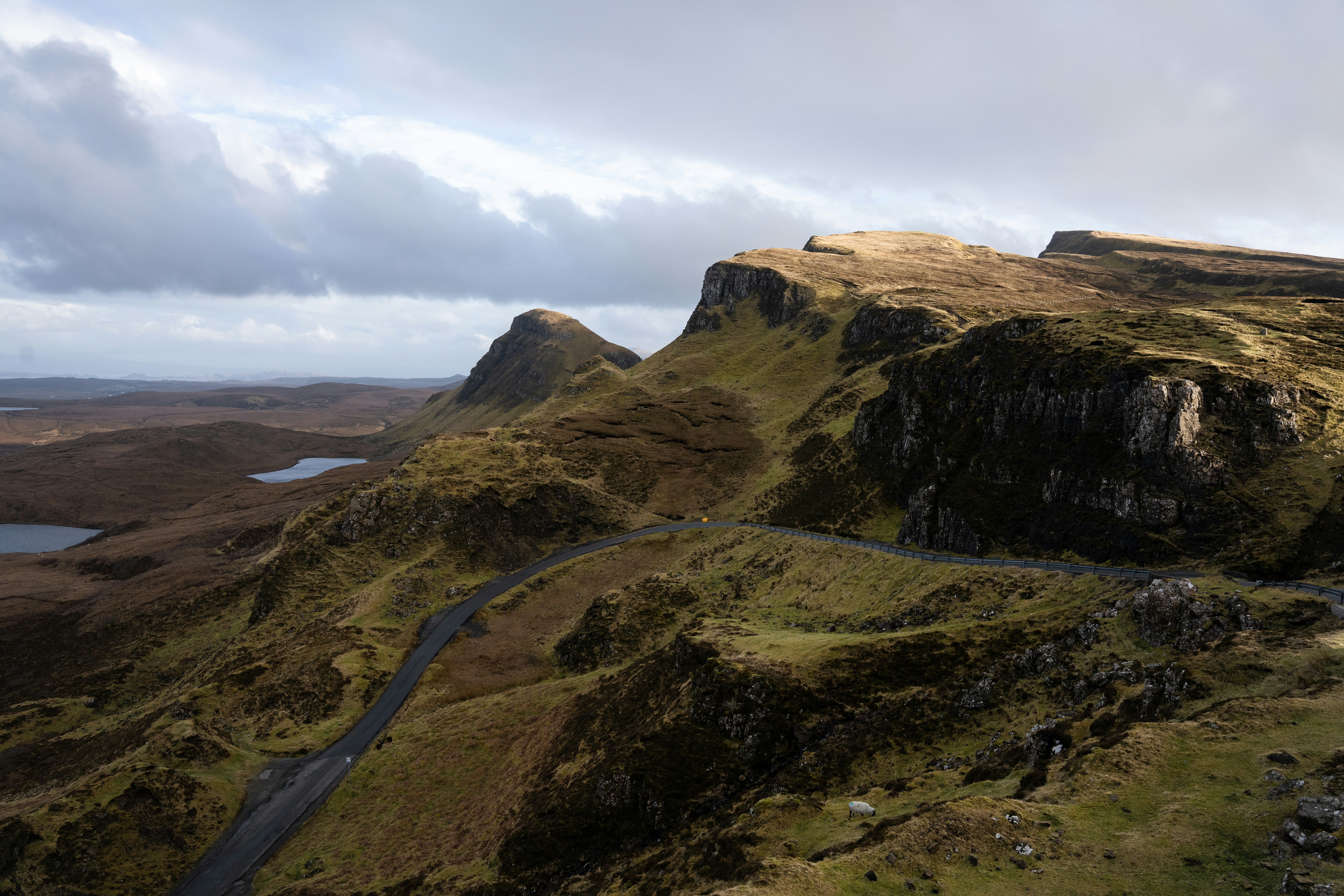 Ridge Road across moorland toward sunlit cliff tops