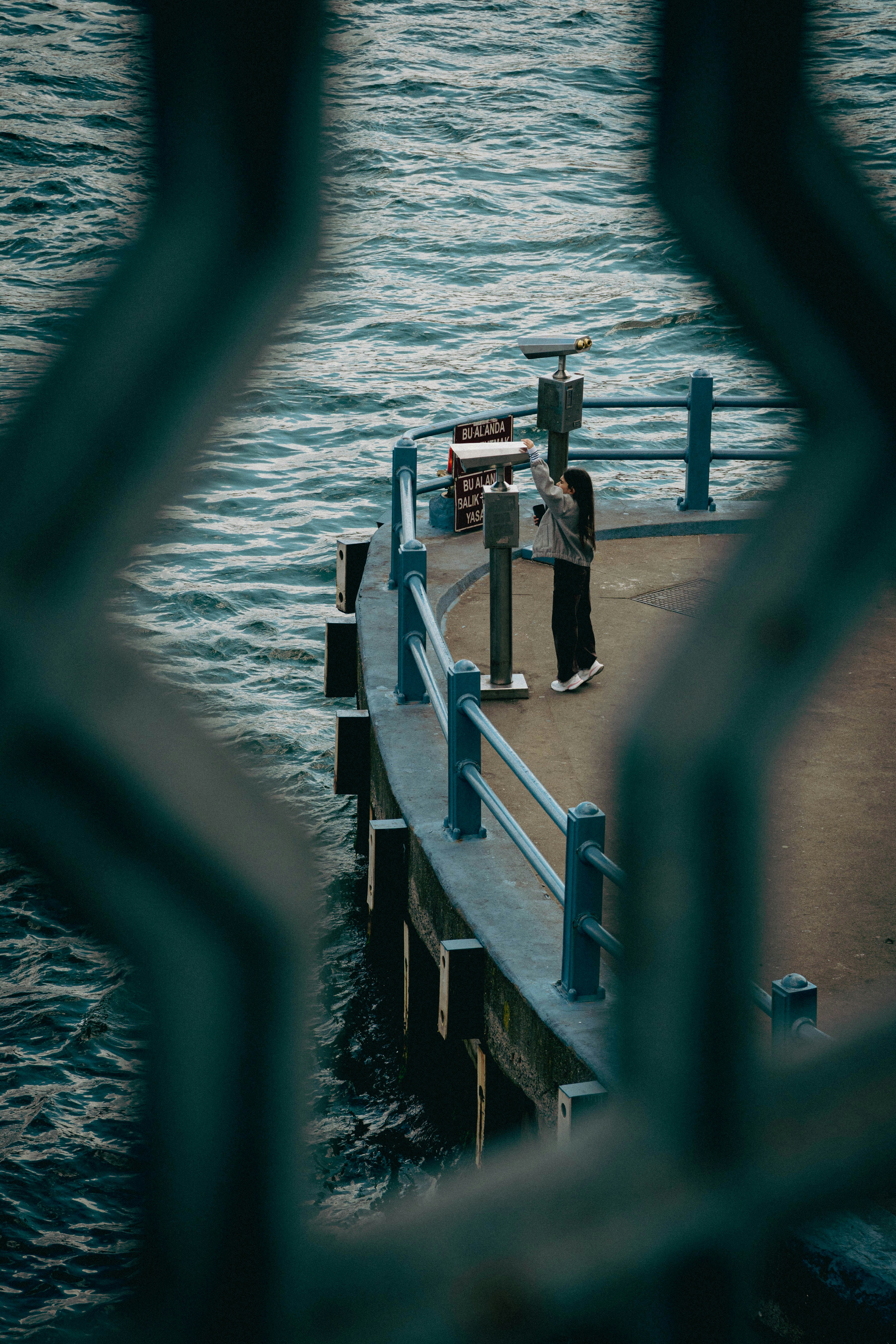 A Quiet Moment at the Pier: Hands by the Telescope