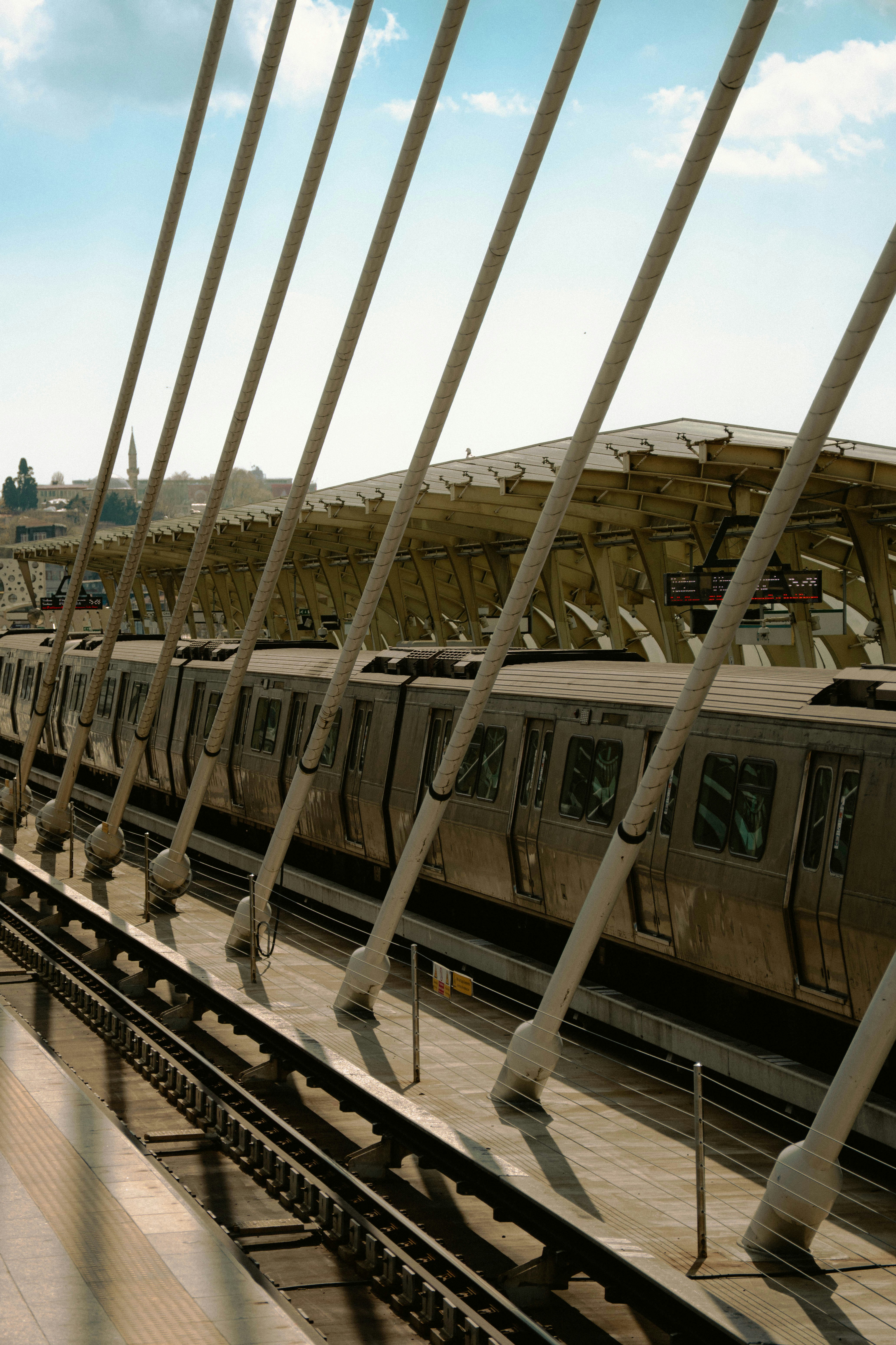 Lines in Motion: A Platform View of a Metallic Train at Dusk