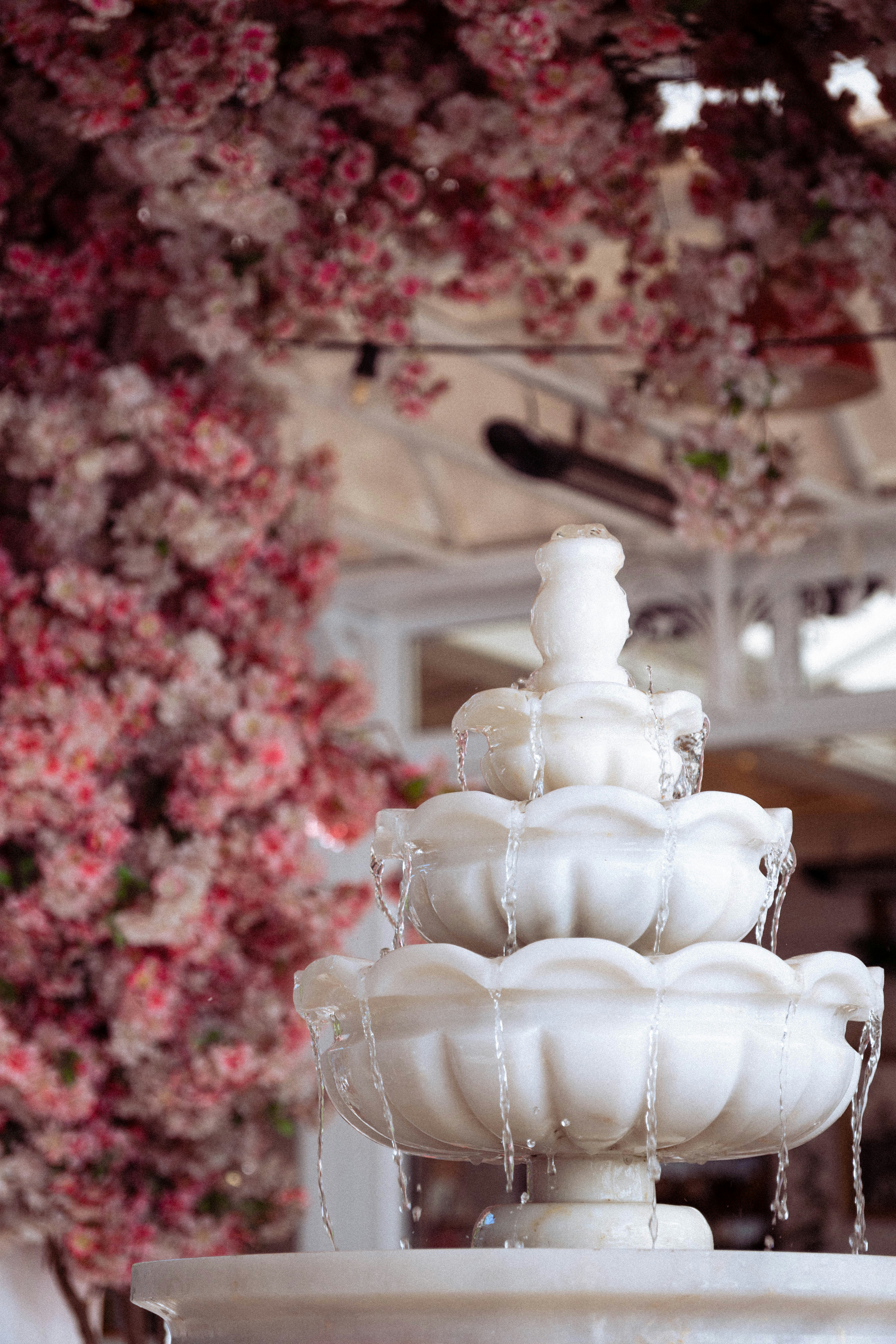 Graceful White Tiers: A Cascading Fountain Amid Blush Florals