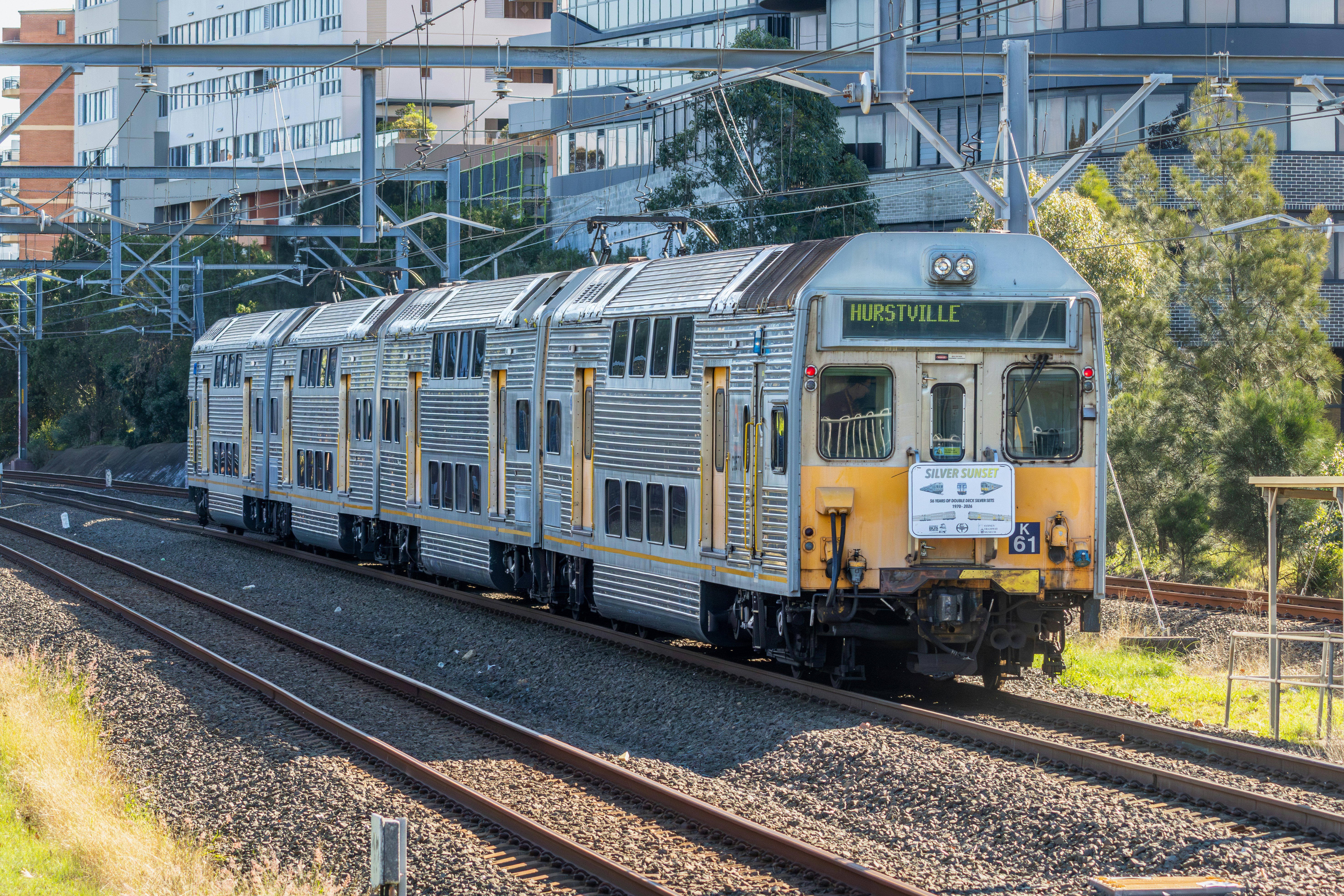Citybound Carriage: A Dual-Deck Train Rides Through the Urban Span