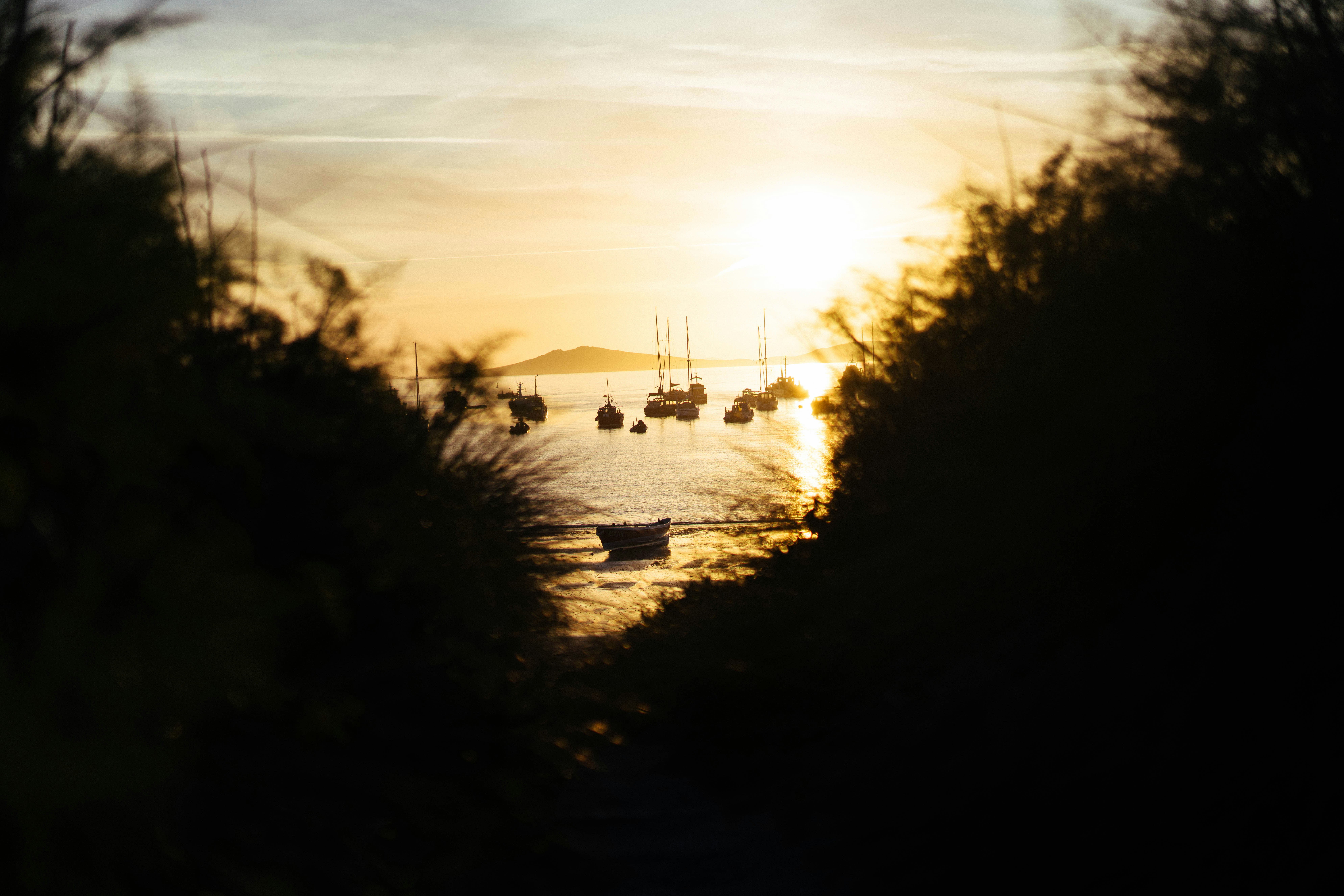 Sunlit Cove: Boats Rest in the Final Glow