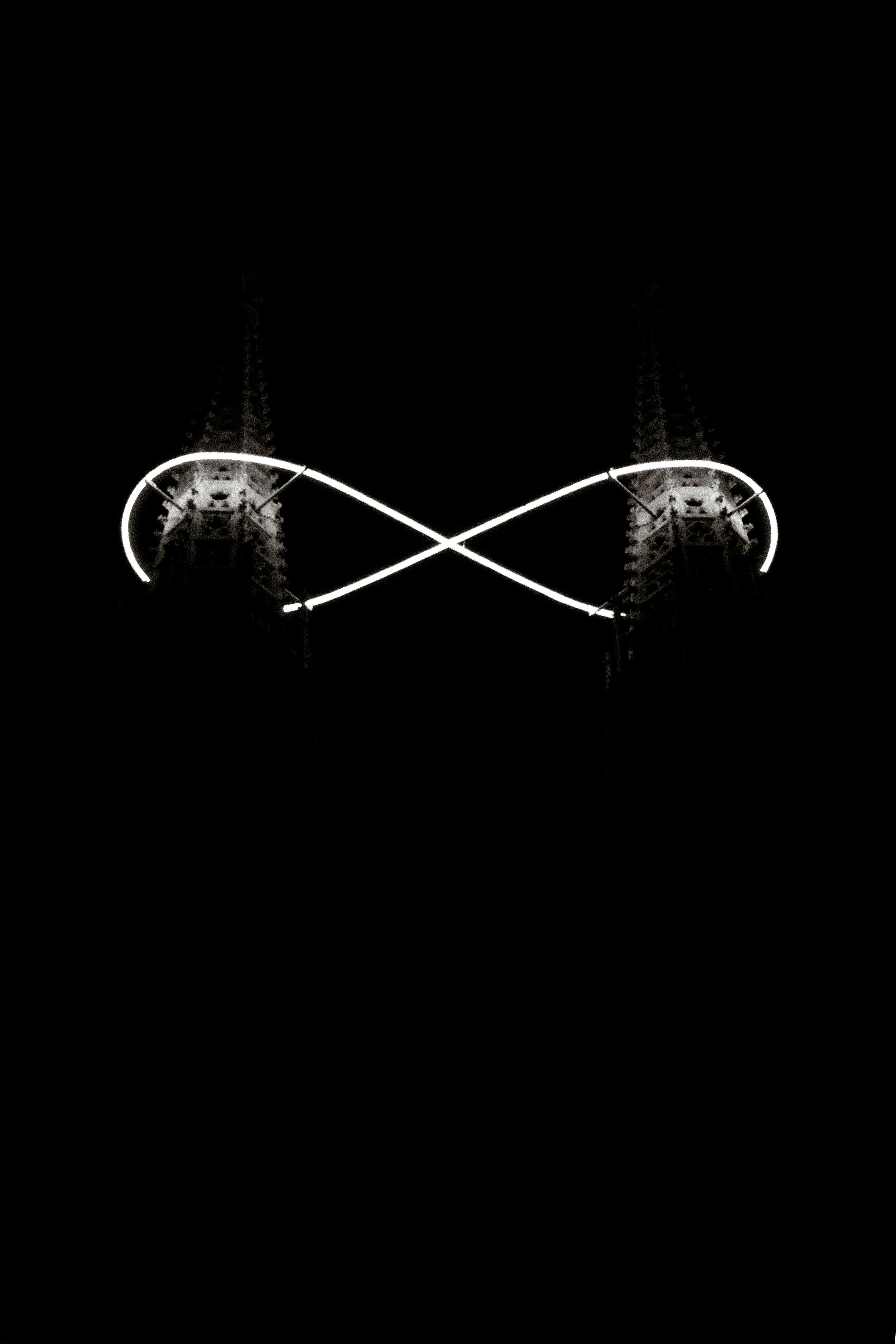 Infinity Between the Wires: A Neon Silhouette in Darkness