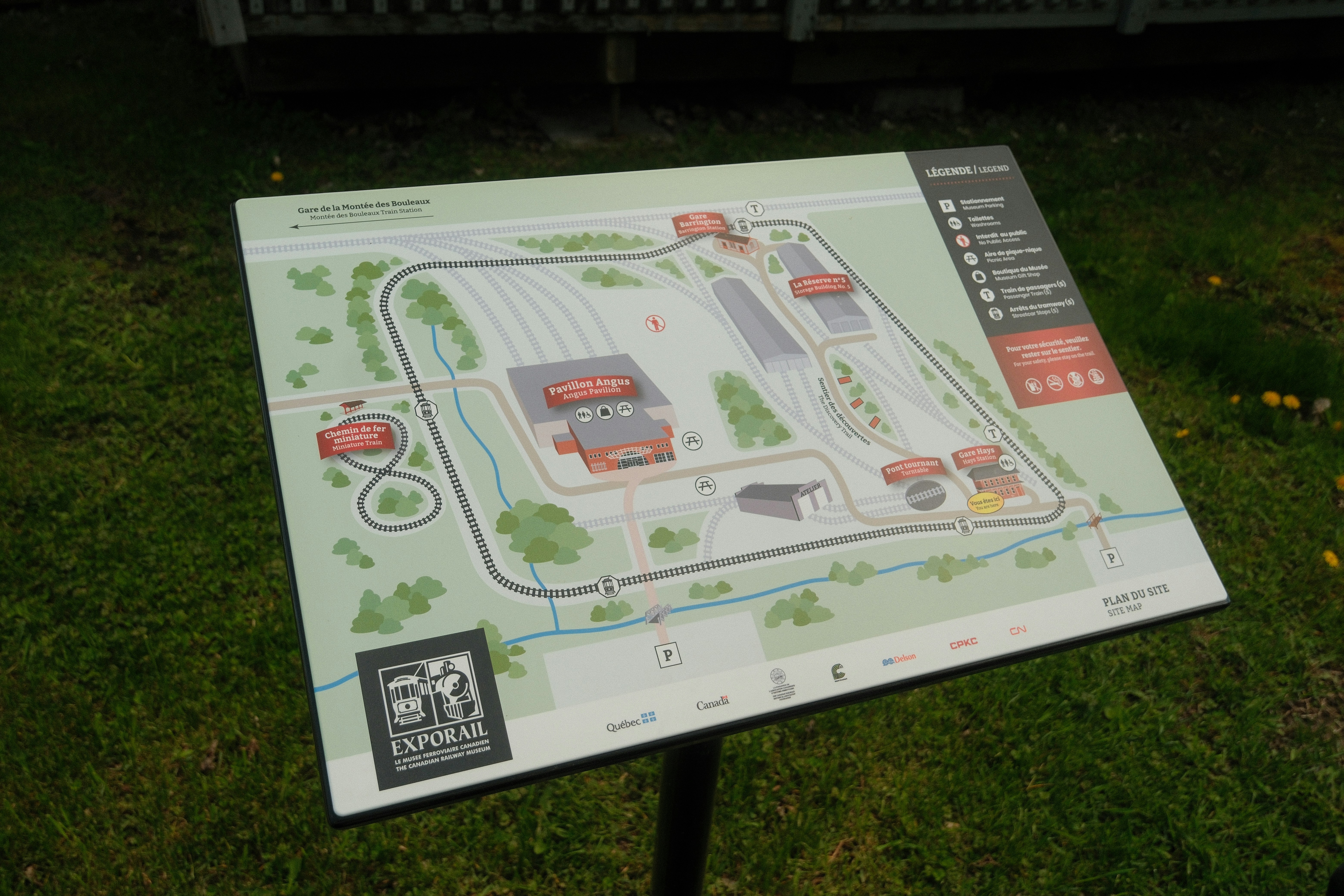 An outdoor map sign showing a park layout.