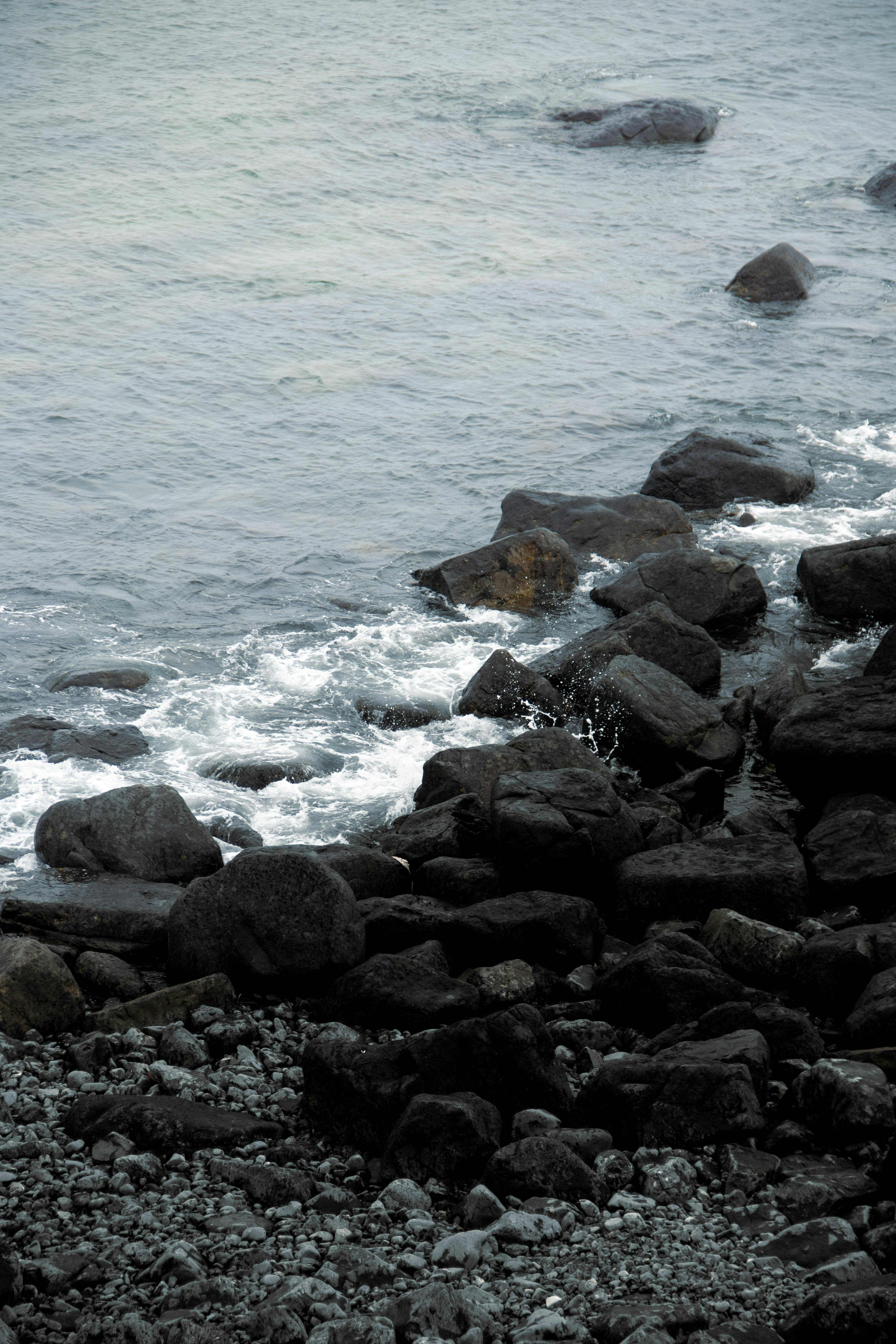 Rugged Shoreline: Black Boulder Beach Meet the Sea