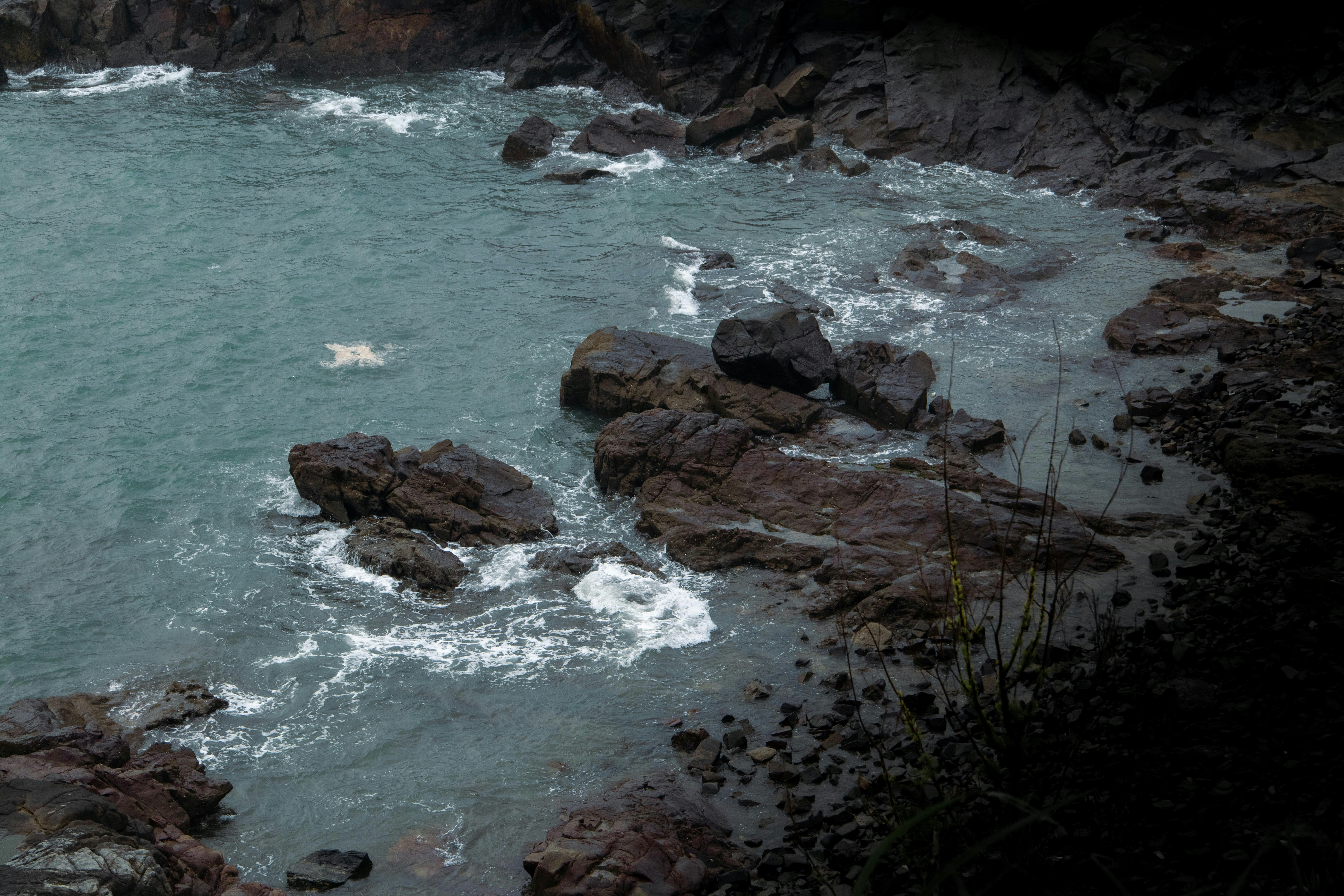 Rugged Tide: Weathered Rocks guarding a the turquoise edge