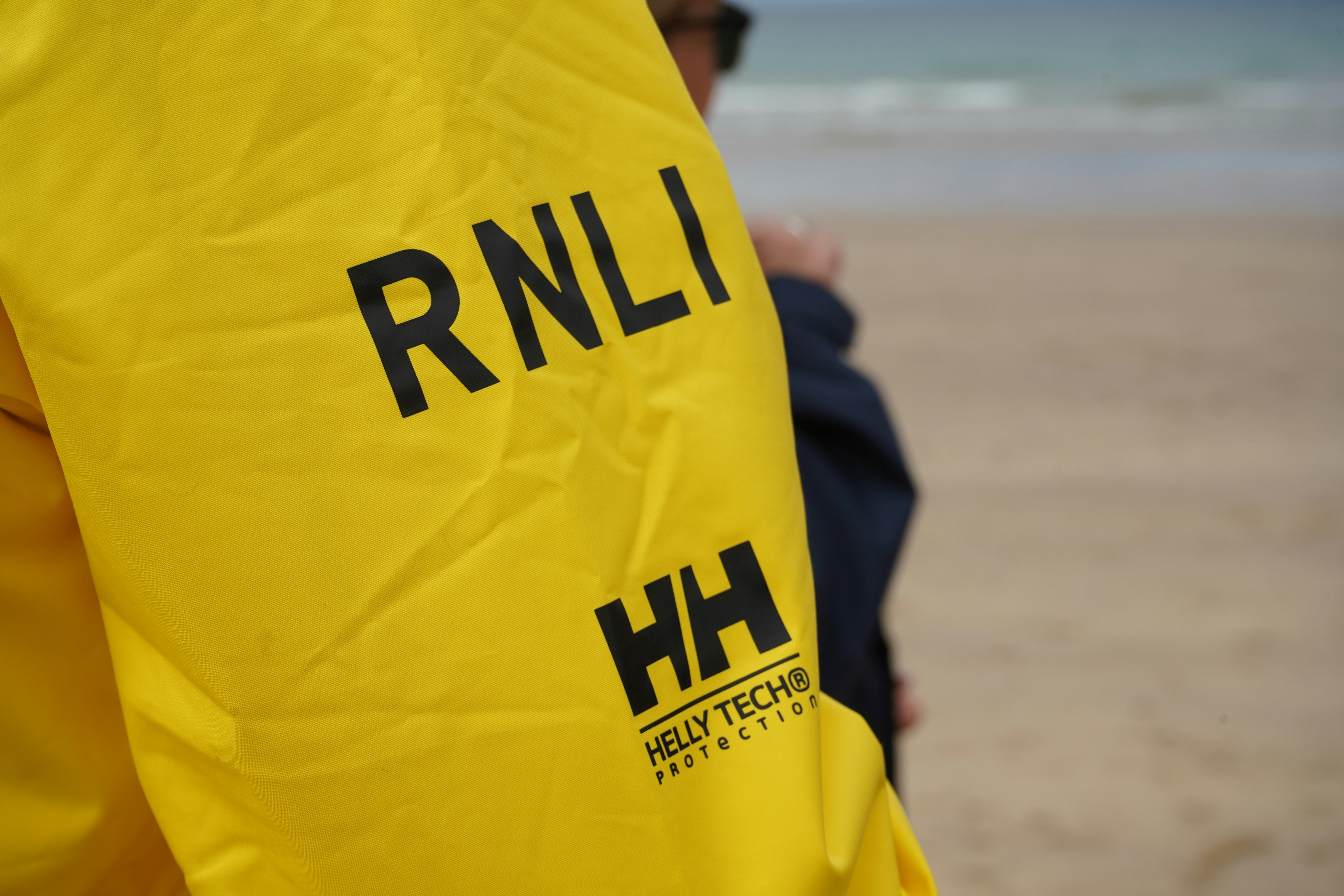 Bright RNLI Jacket at the Quiet Beach Edge