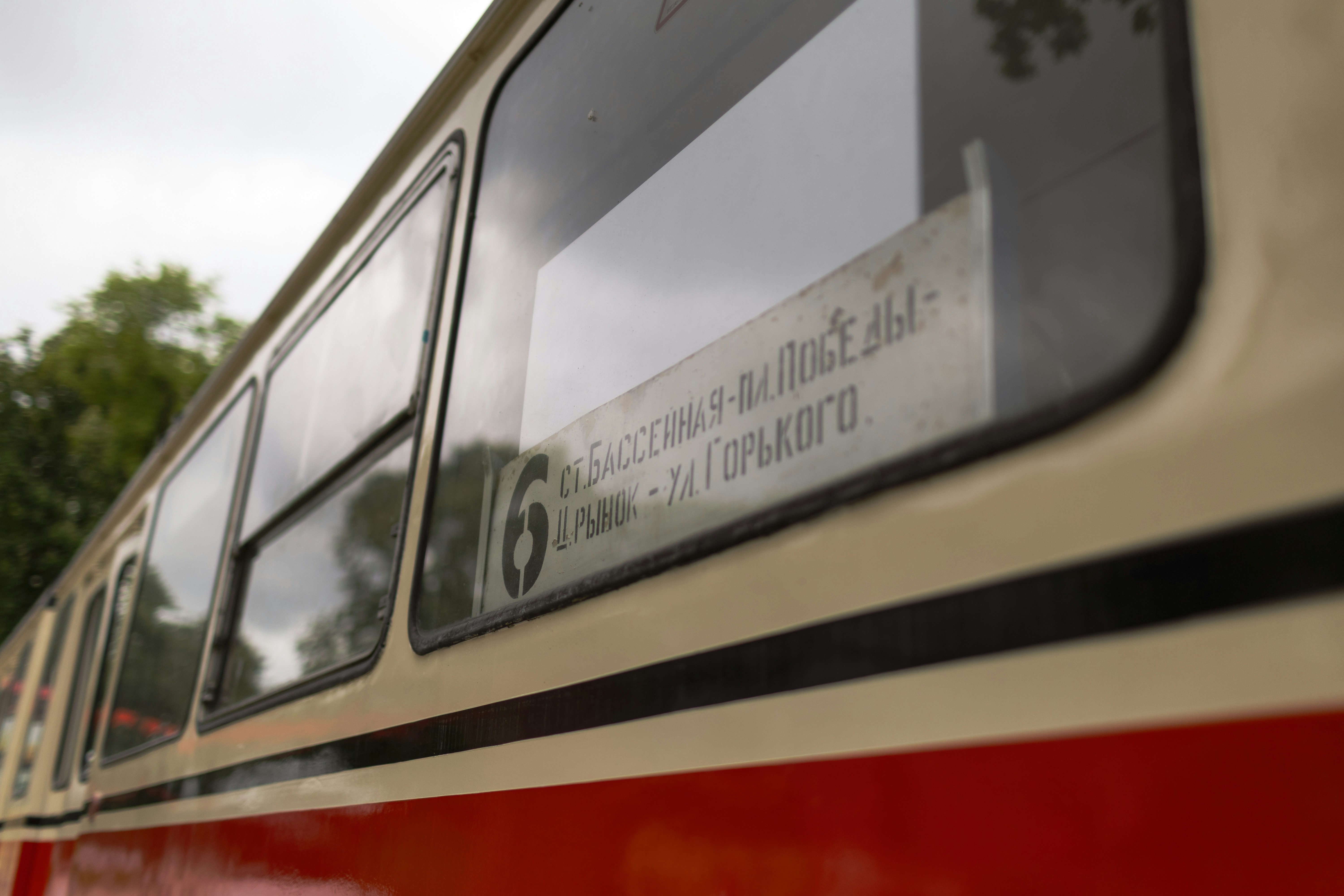 Side of a vintage train in motion with window reflections