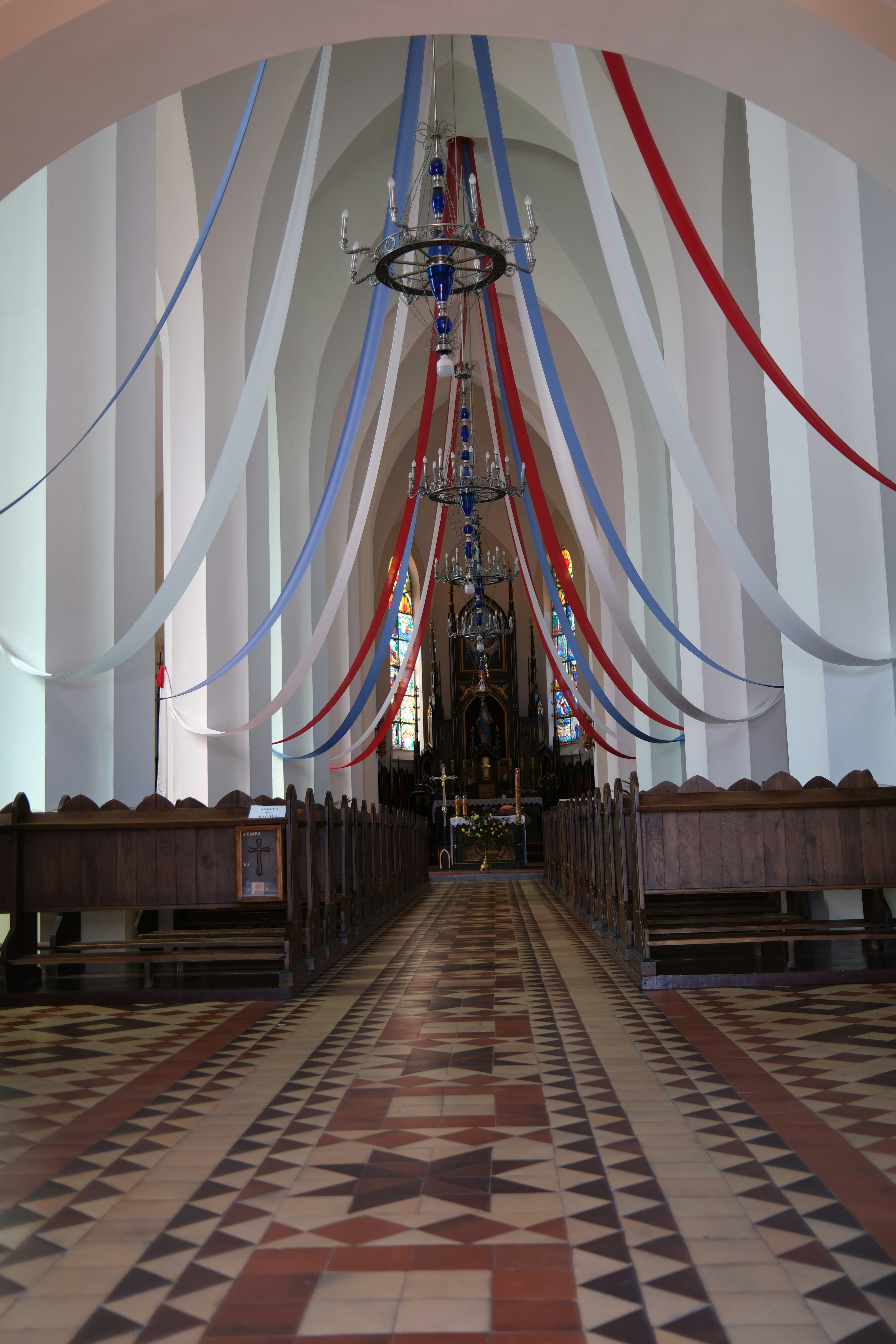 Ribboned Cathedral Aisle: Colors Guiding Toward the Altar