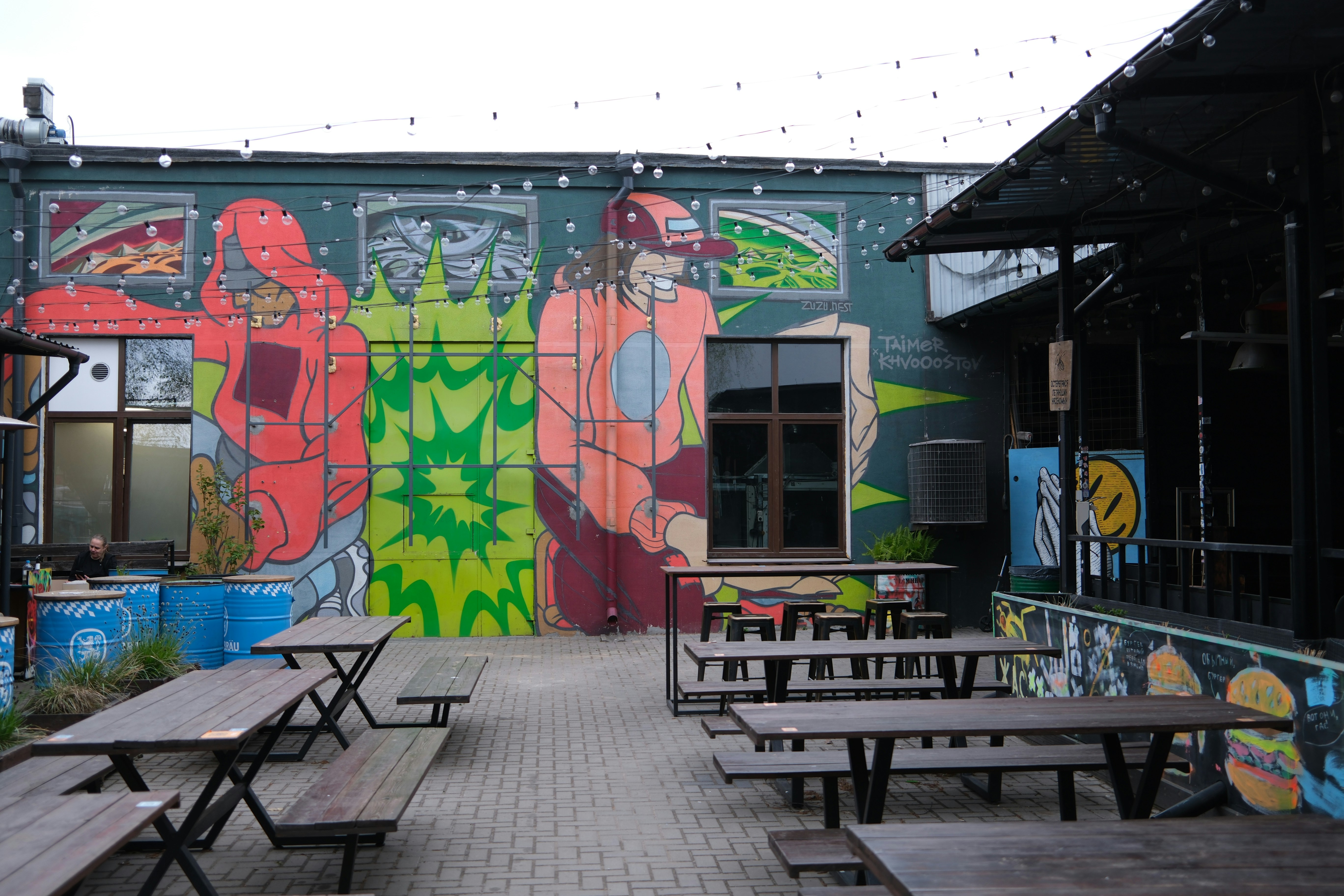 Urban mural courtyard: fruit of graffiti and wood benches