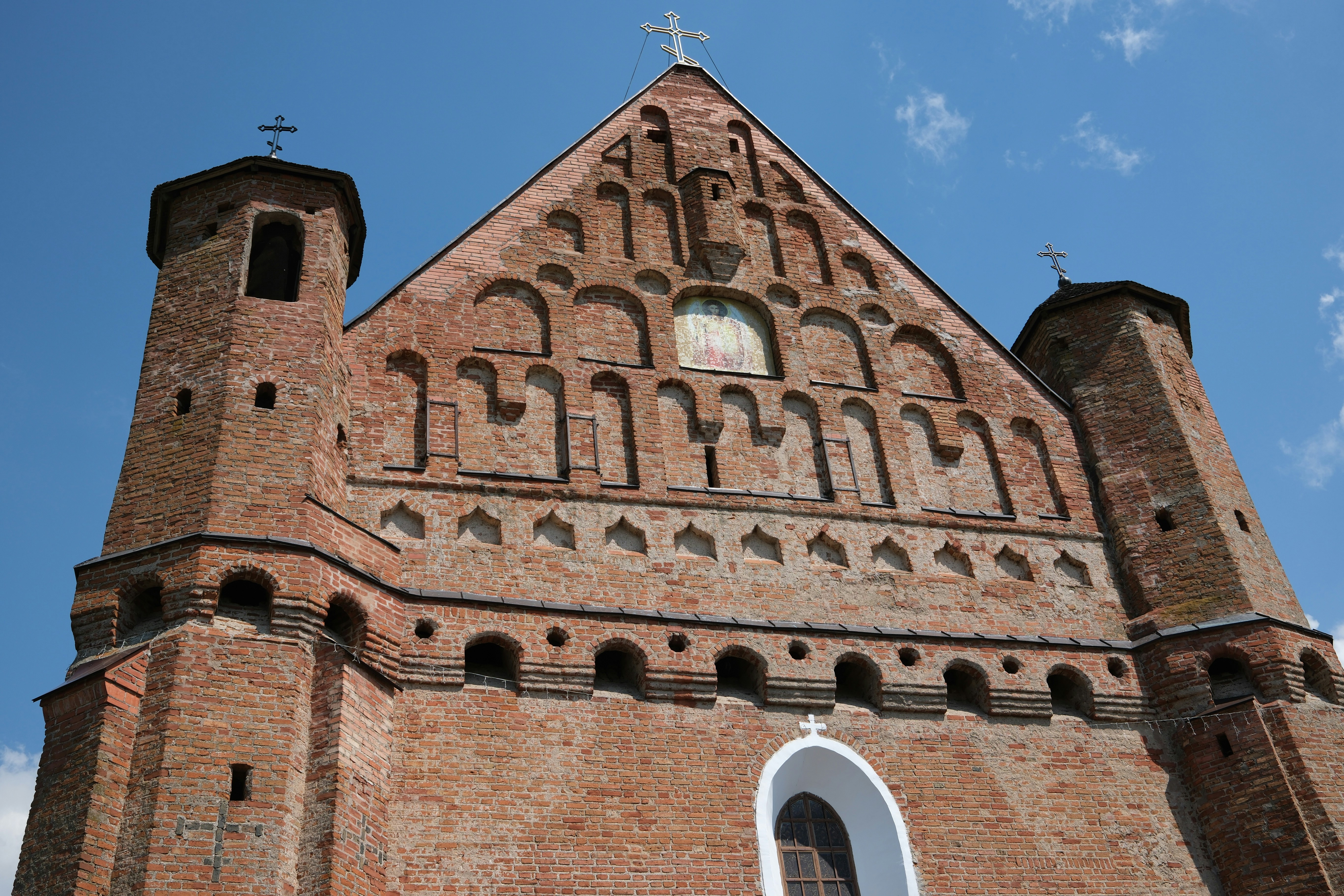 Brick Basilica Rise: A Gabled Facade Reaching Toward the Sky