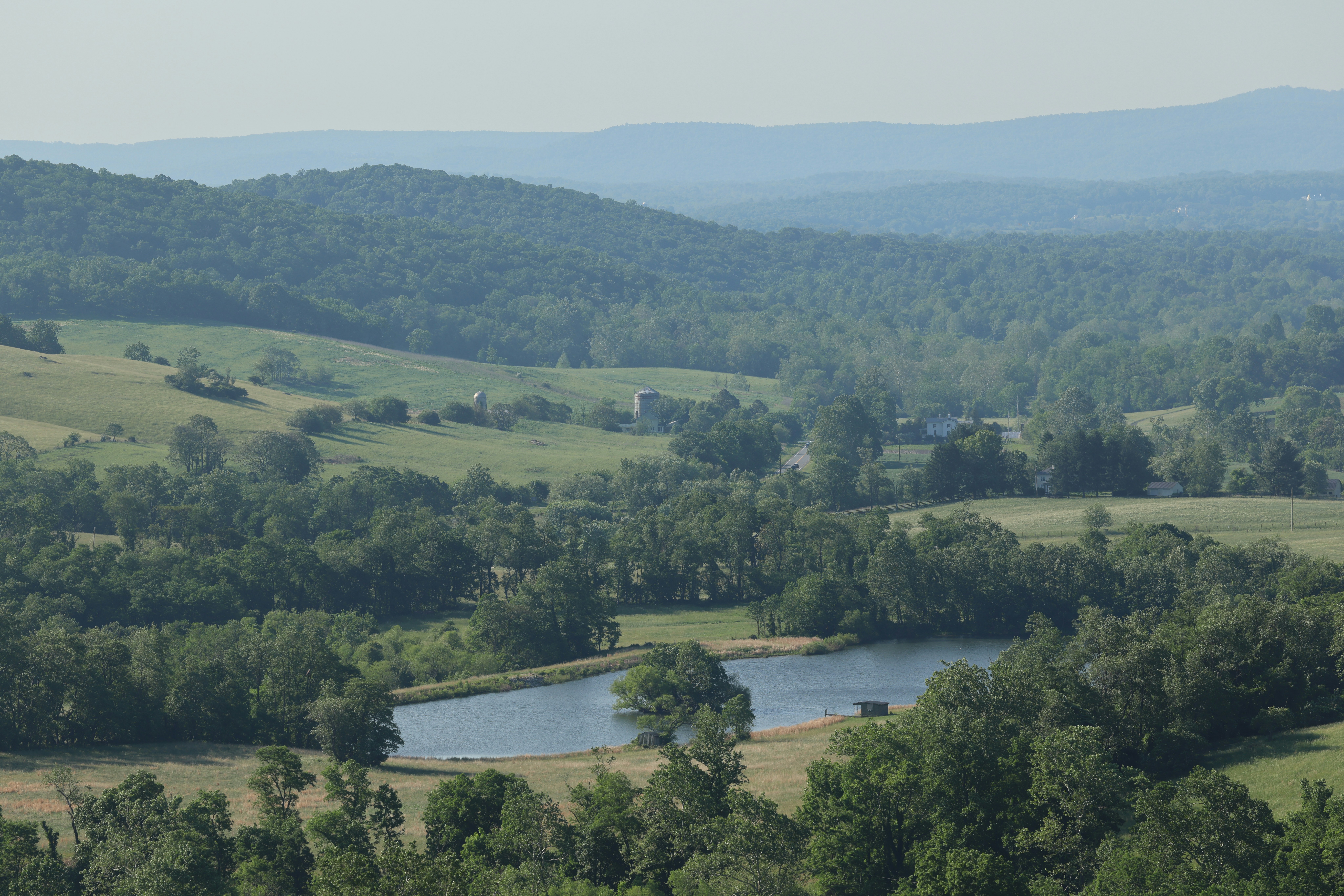 A Quiet Lake Nestled Between Rolling Hills