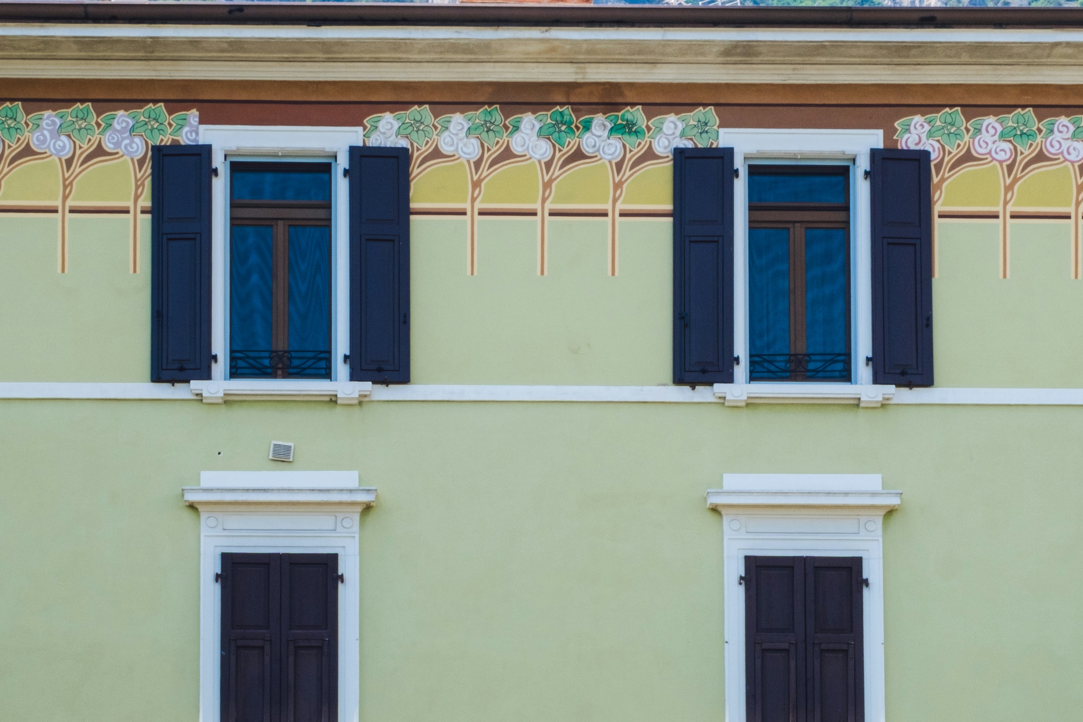 Pastel Facade with Distinctive Window Shutters