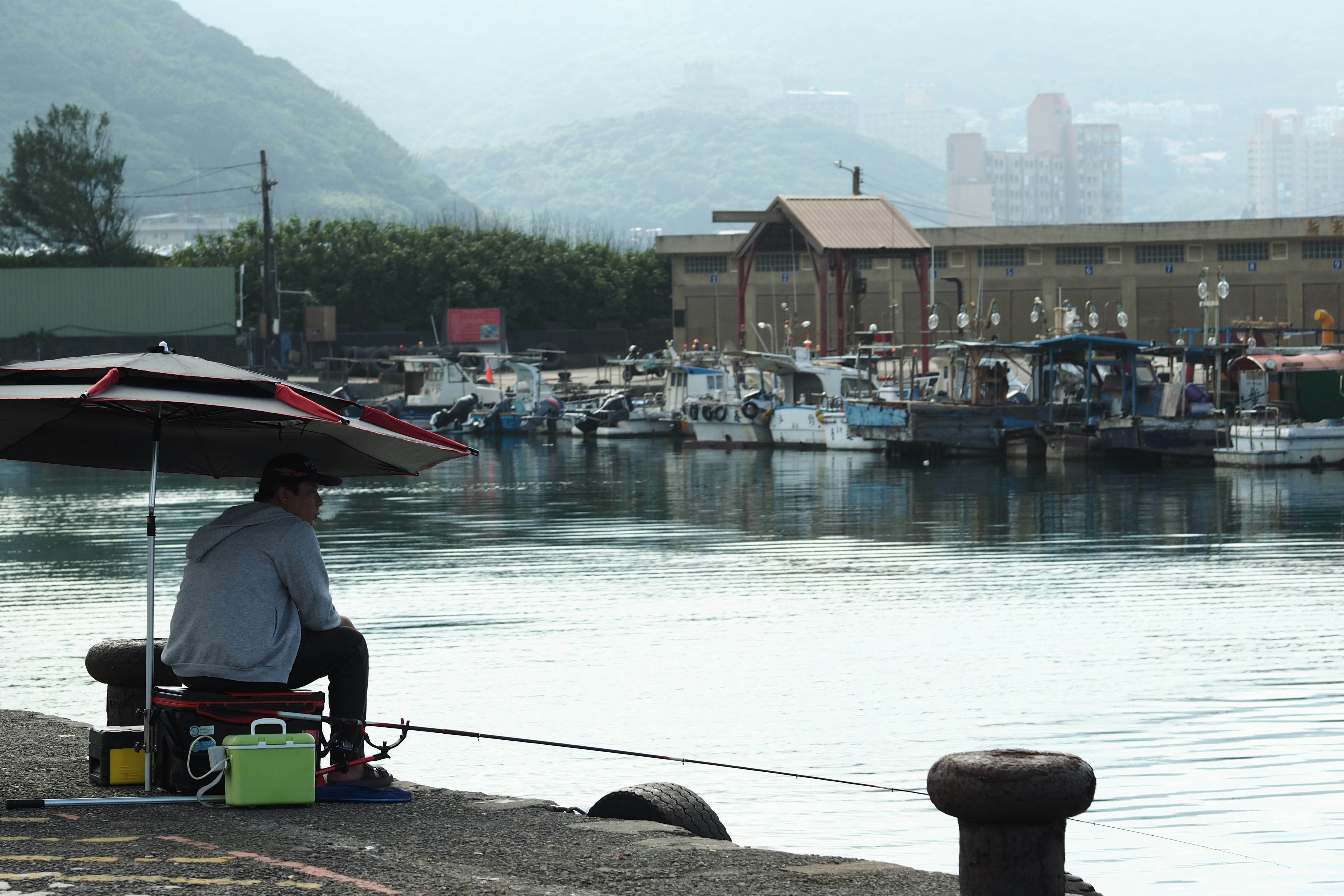 Quiet harbor fisherman at dusk, tethered to the quay