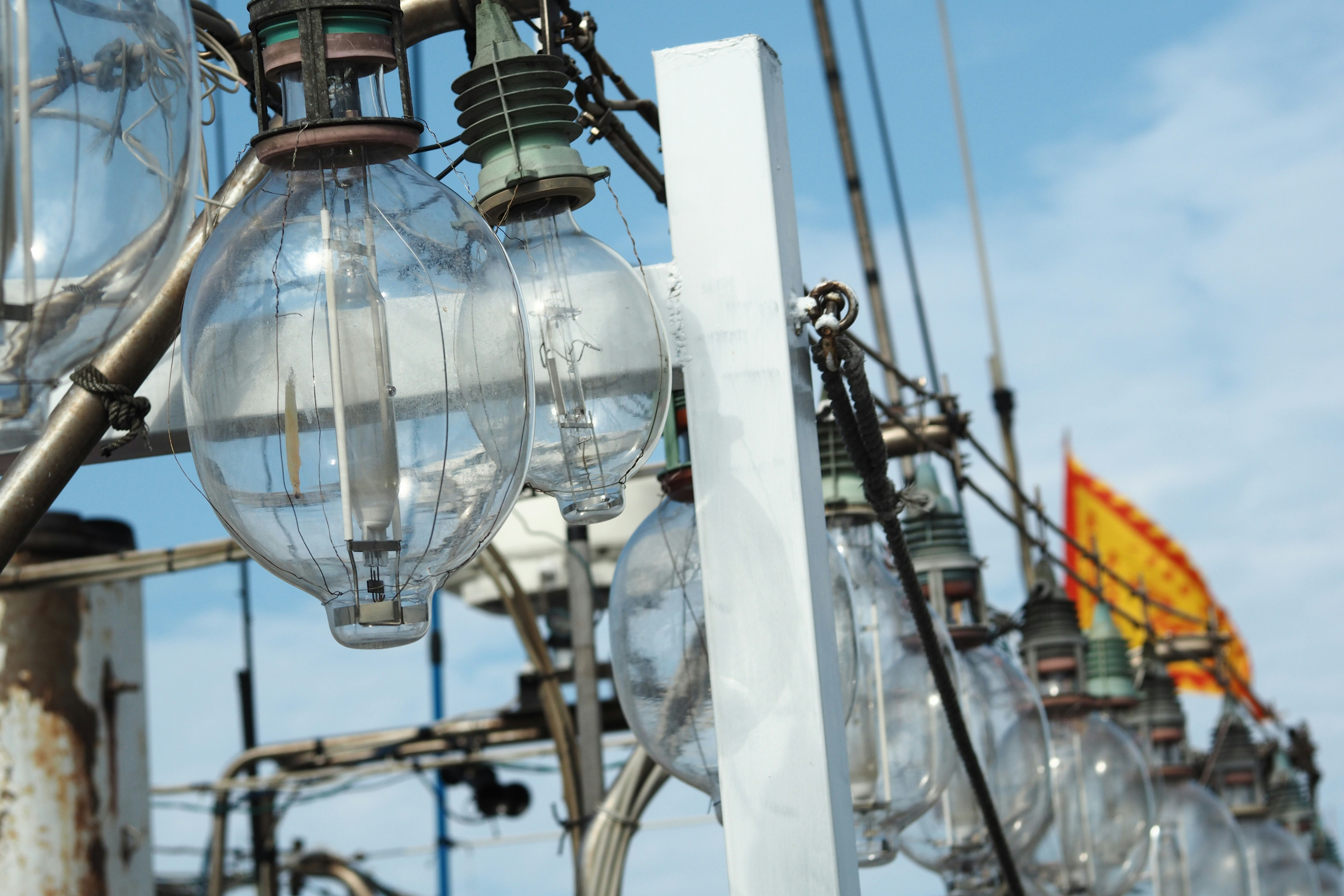 String of Glass Orbs on Weathered Rails Under a Bright Sky