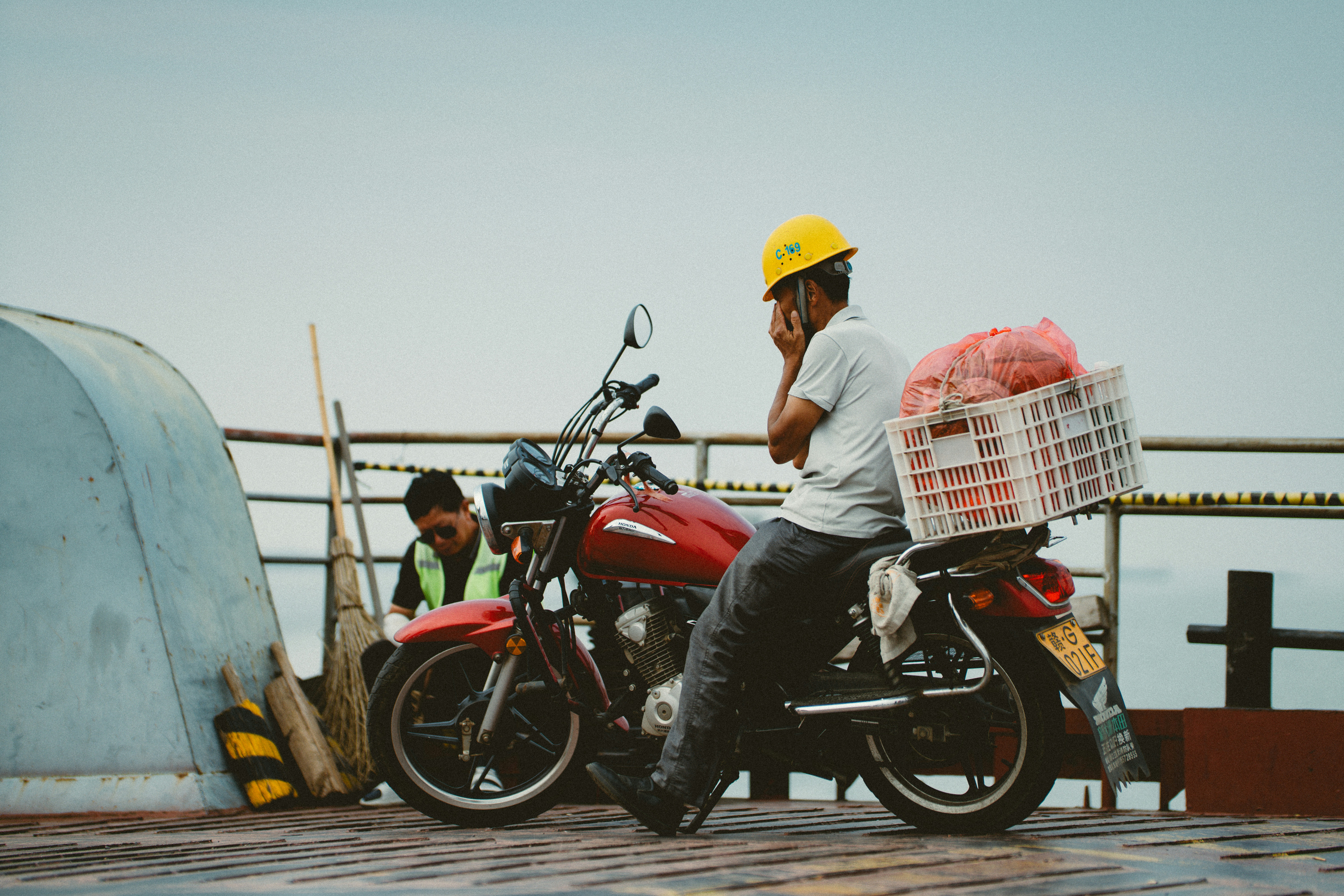 Helmeted Messenger by the Shoreline: A Quiet Moment on the Platform