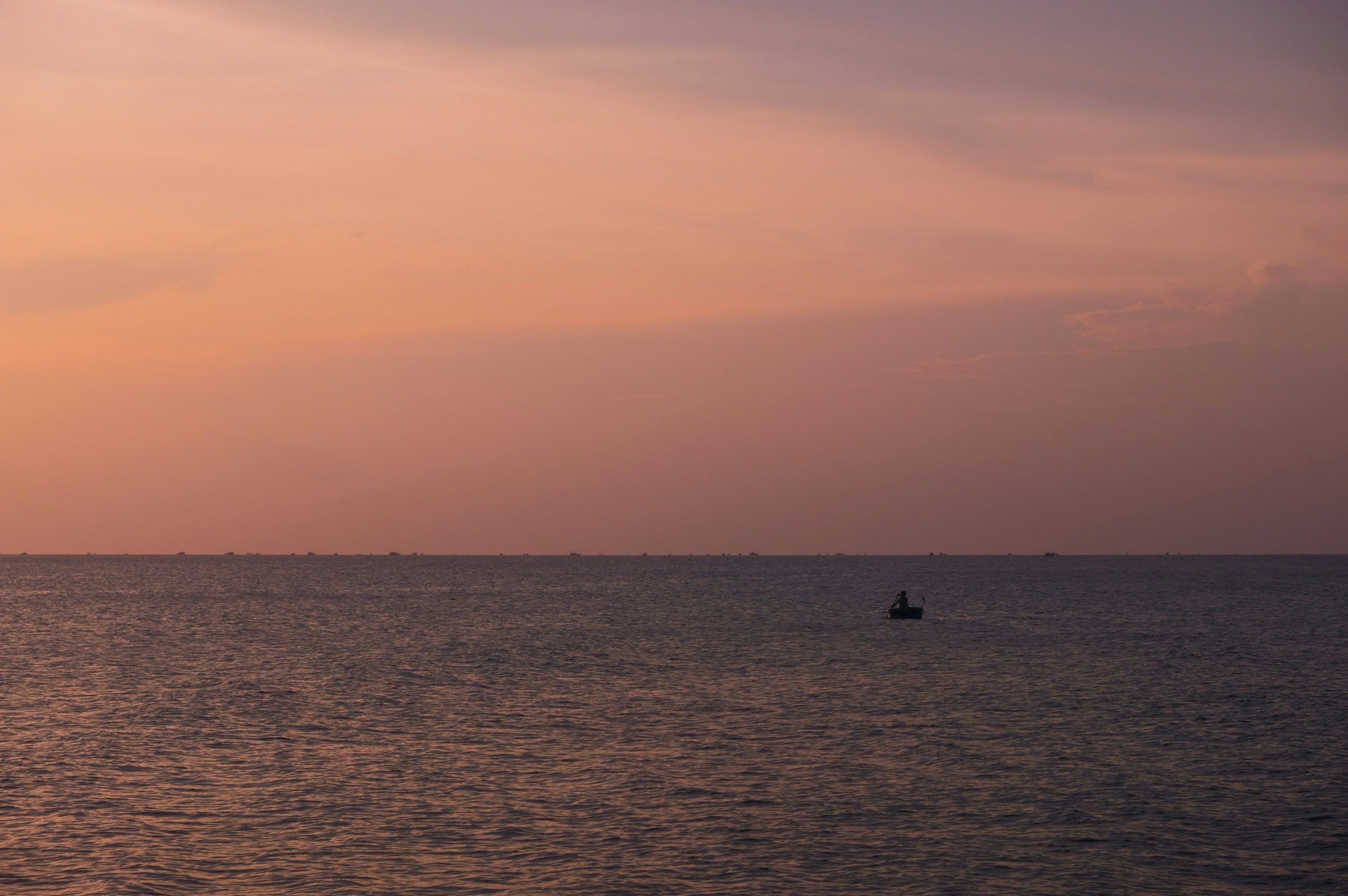 A Quiet Horizon: Boat on a Calmed Evening Sea