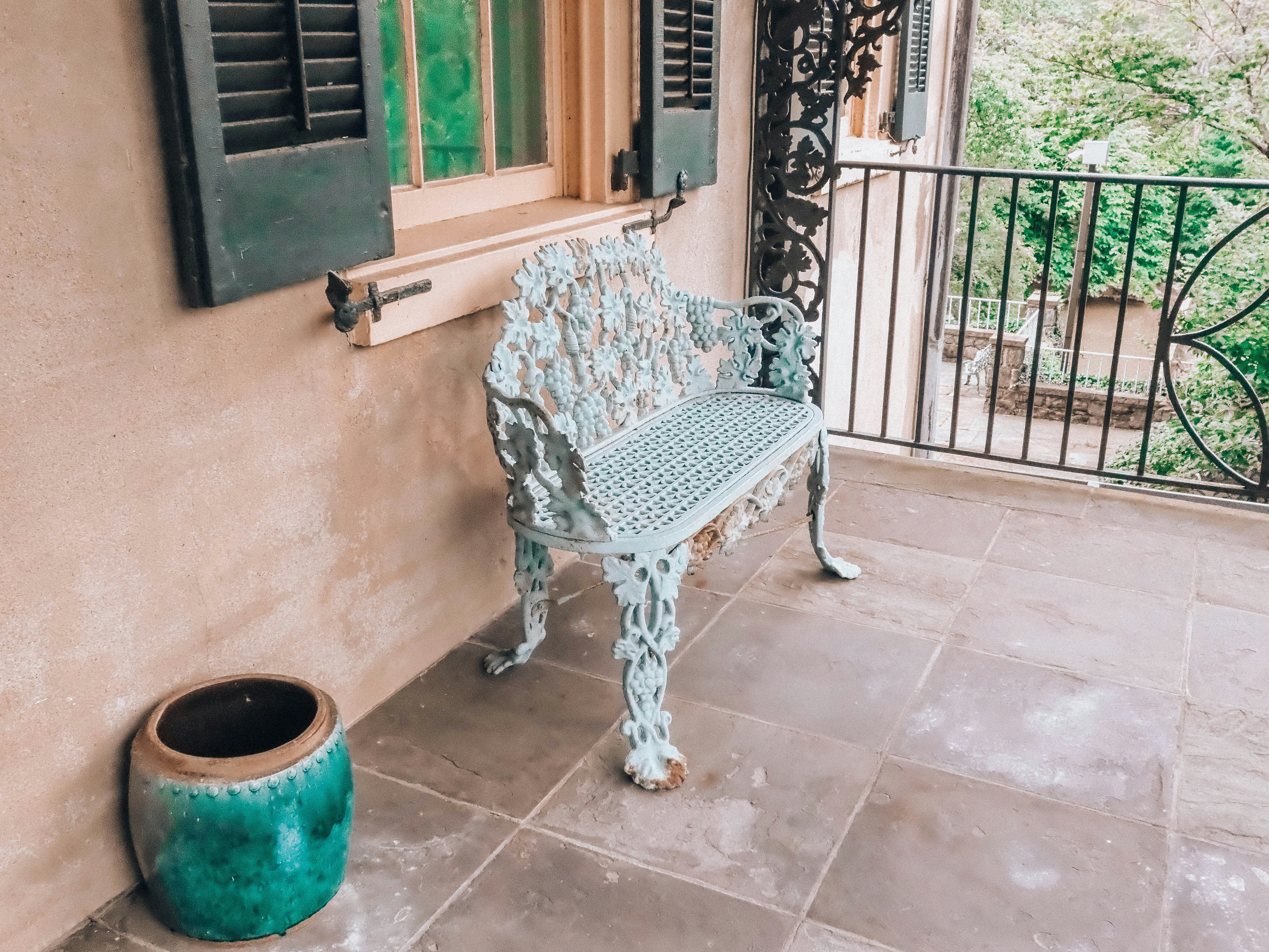 Wrought-iron bench on a sunlit veranda