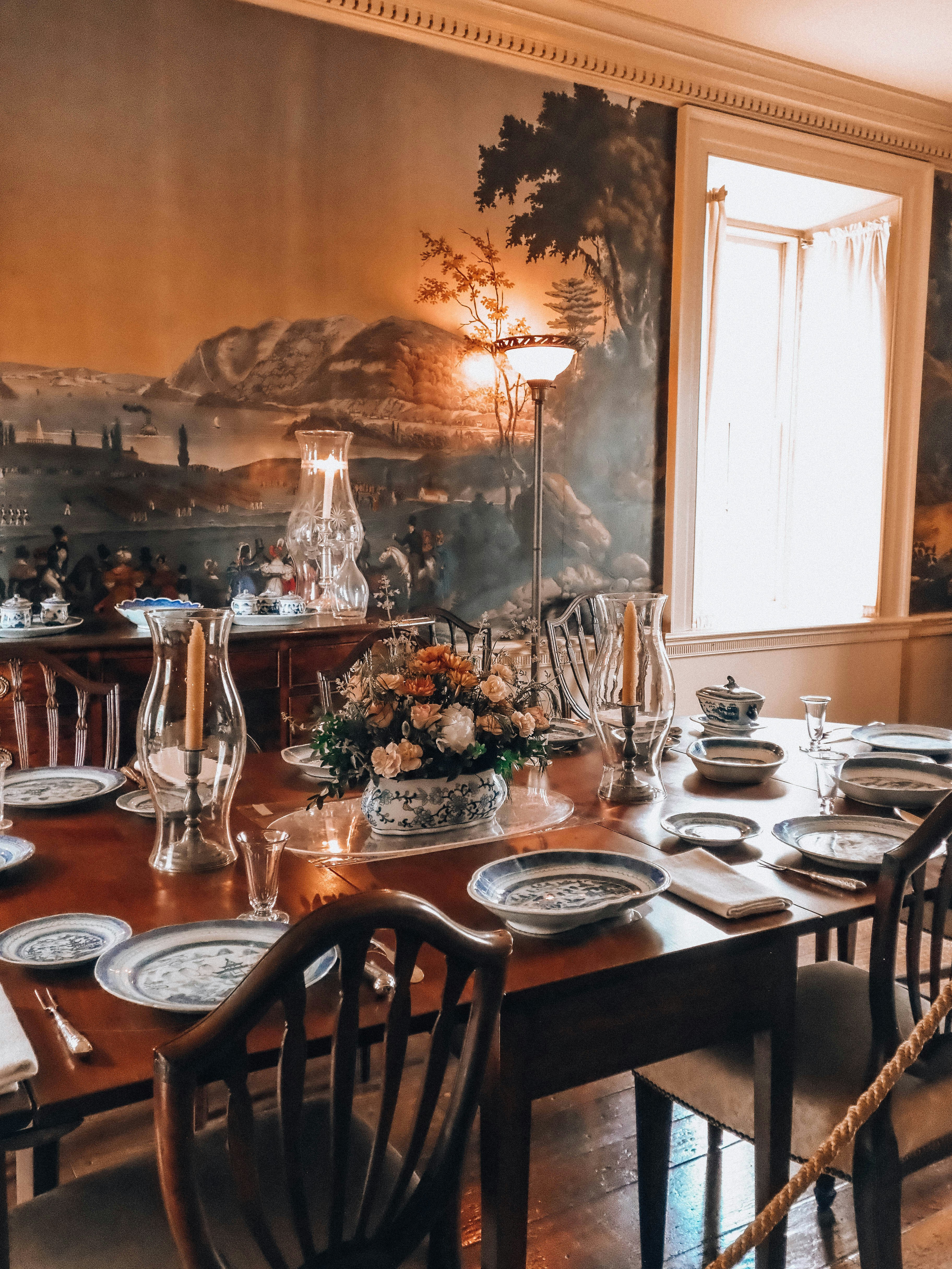 Elegant banquet in a sunlit dining room with vintage china