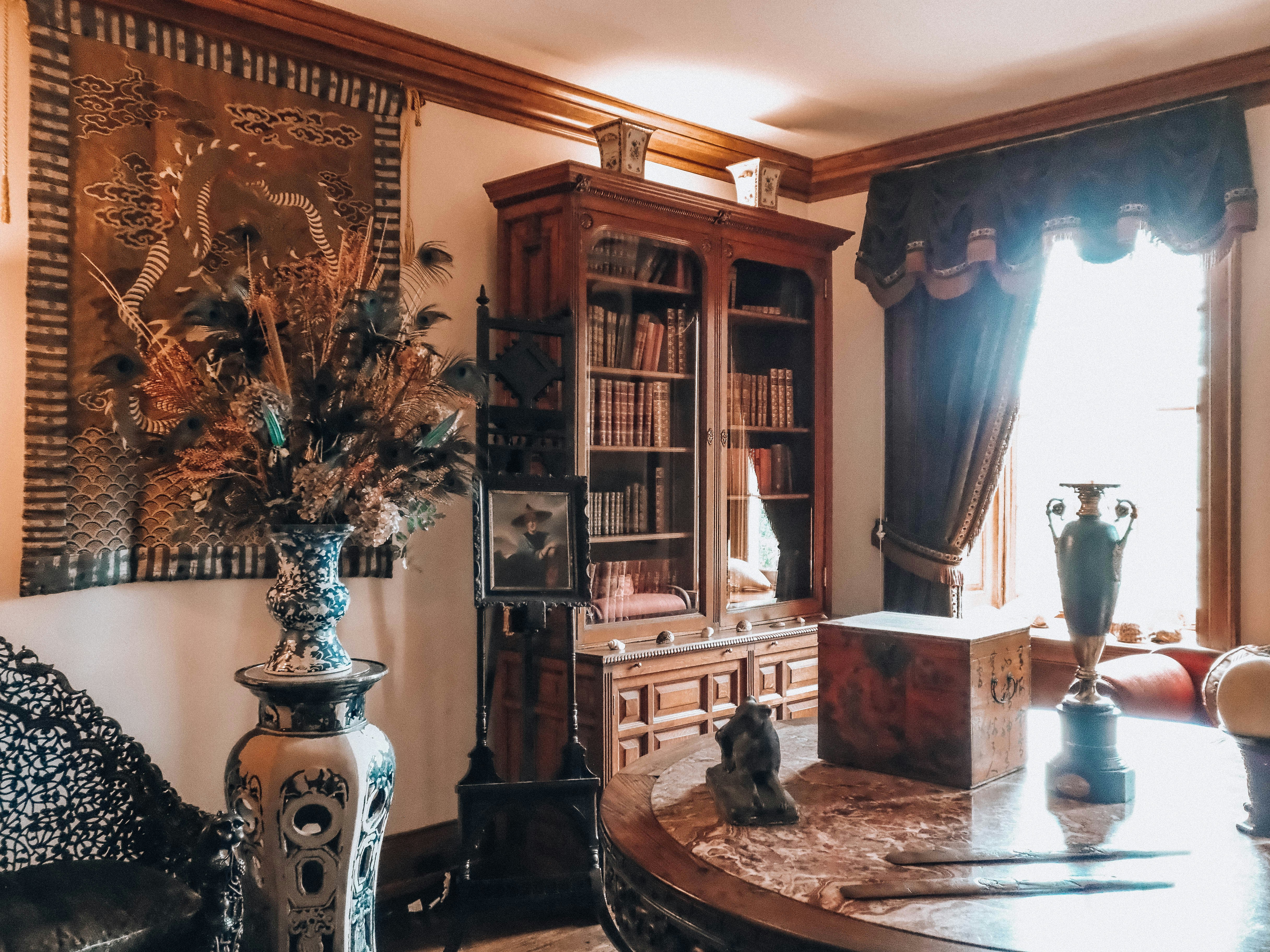 Ornate Library Nook with Vintage Vase and Silk Drapes